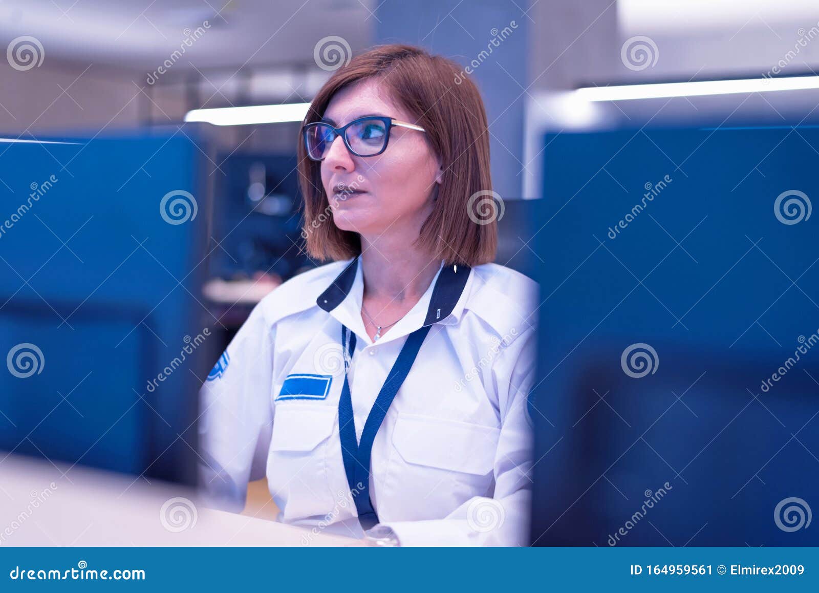 Female Security Guard Working on Computers while Sitting in the Main ...