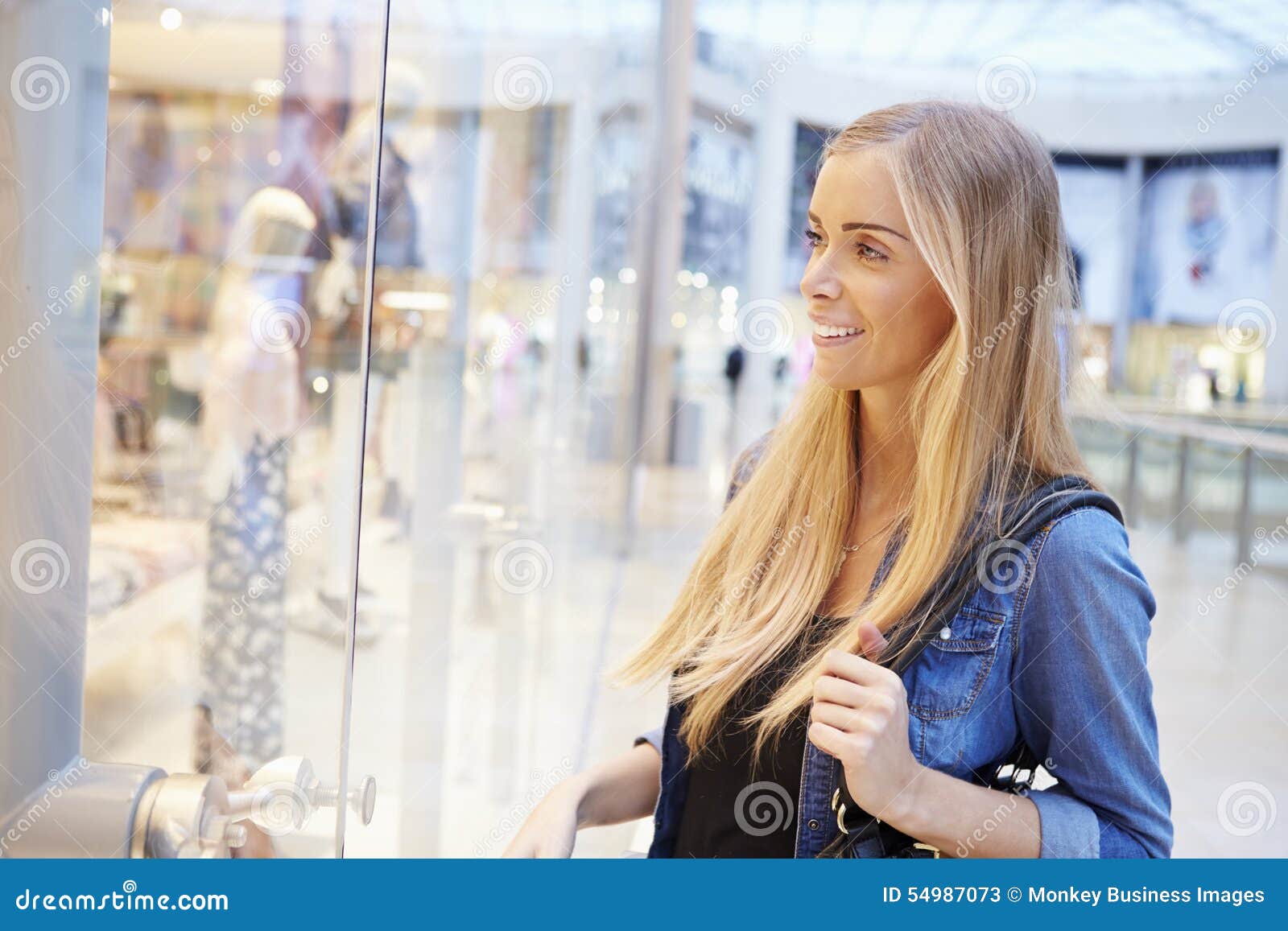 Female Shopper Looking in Store Window Inside Shopping Mall Stock Image ...