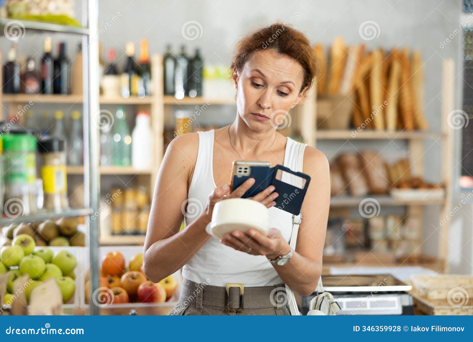 Female Shopper Scans QR Code on Cheese Label Using Smartphone. Checking ...