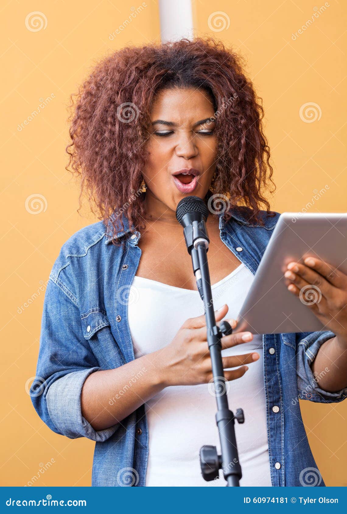 Female Singer Holding Tablet Computer while Stock Image - Image of ...