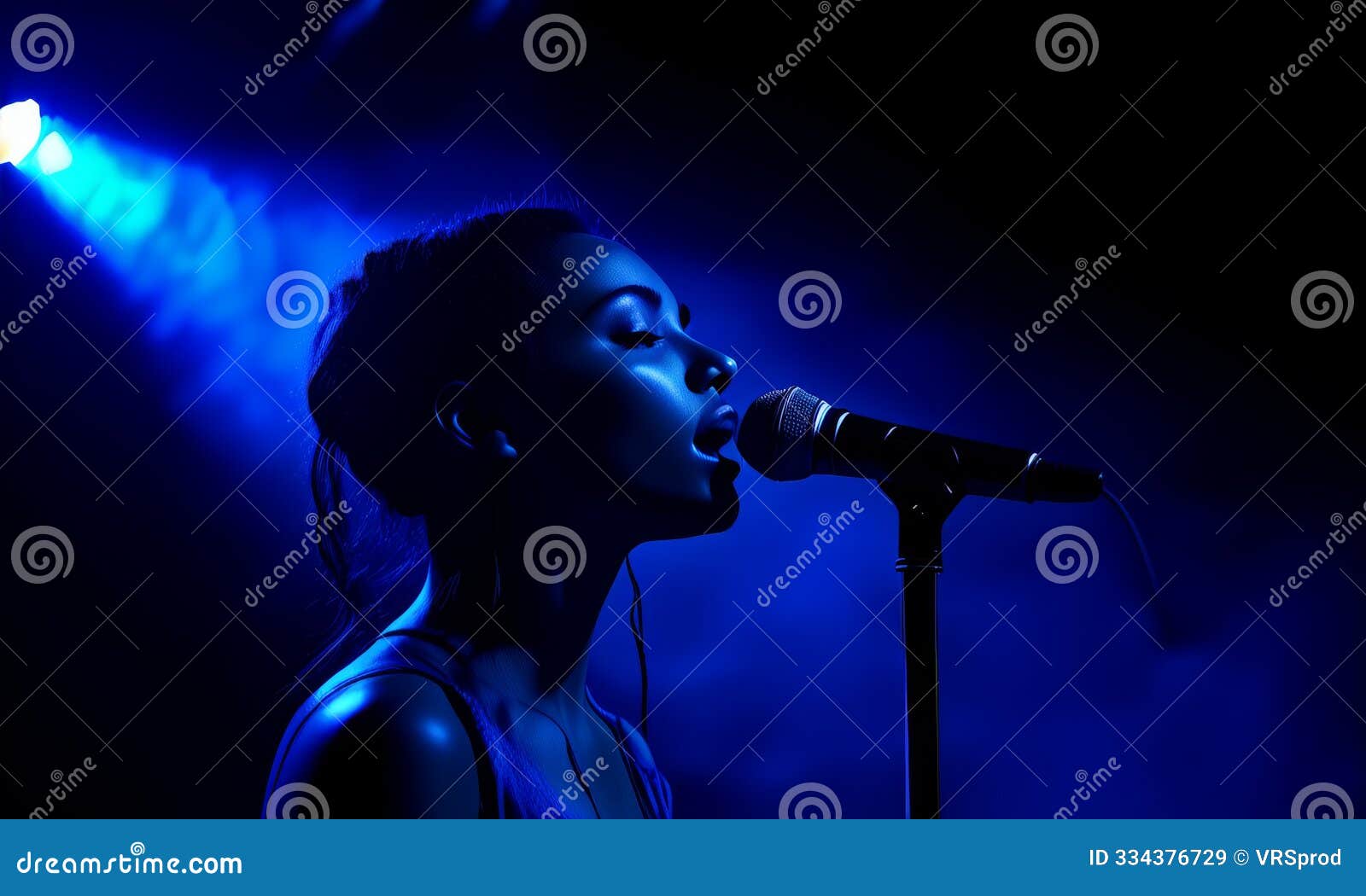 Female Singer Performing Under Blue Stage Lights Stock Image - Image of ...