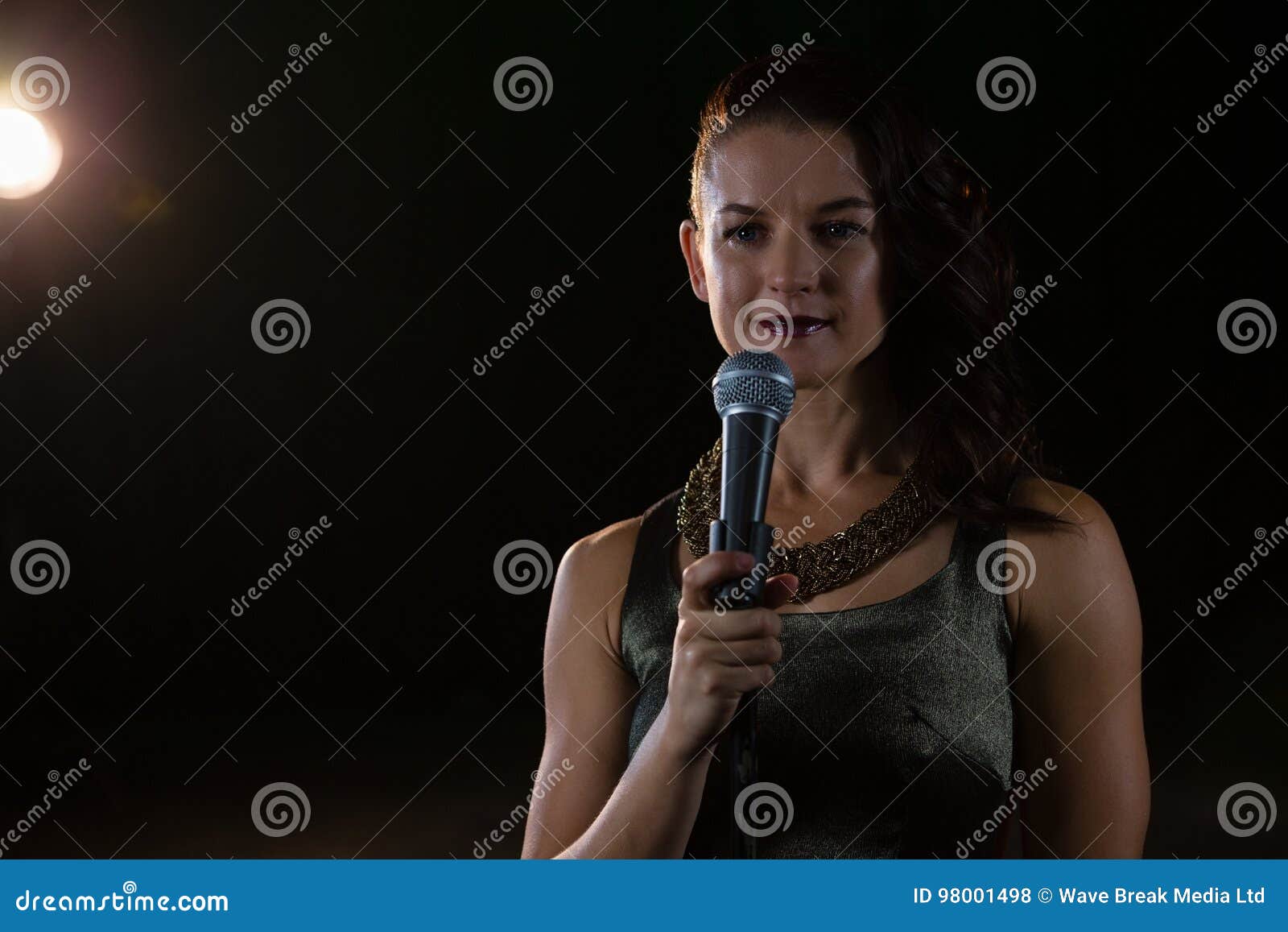 Female Singer Singing into a Microphone Stock Photo - Image of ...