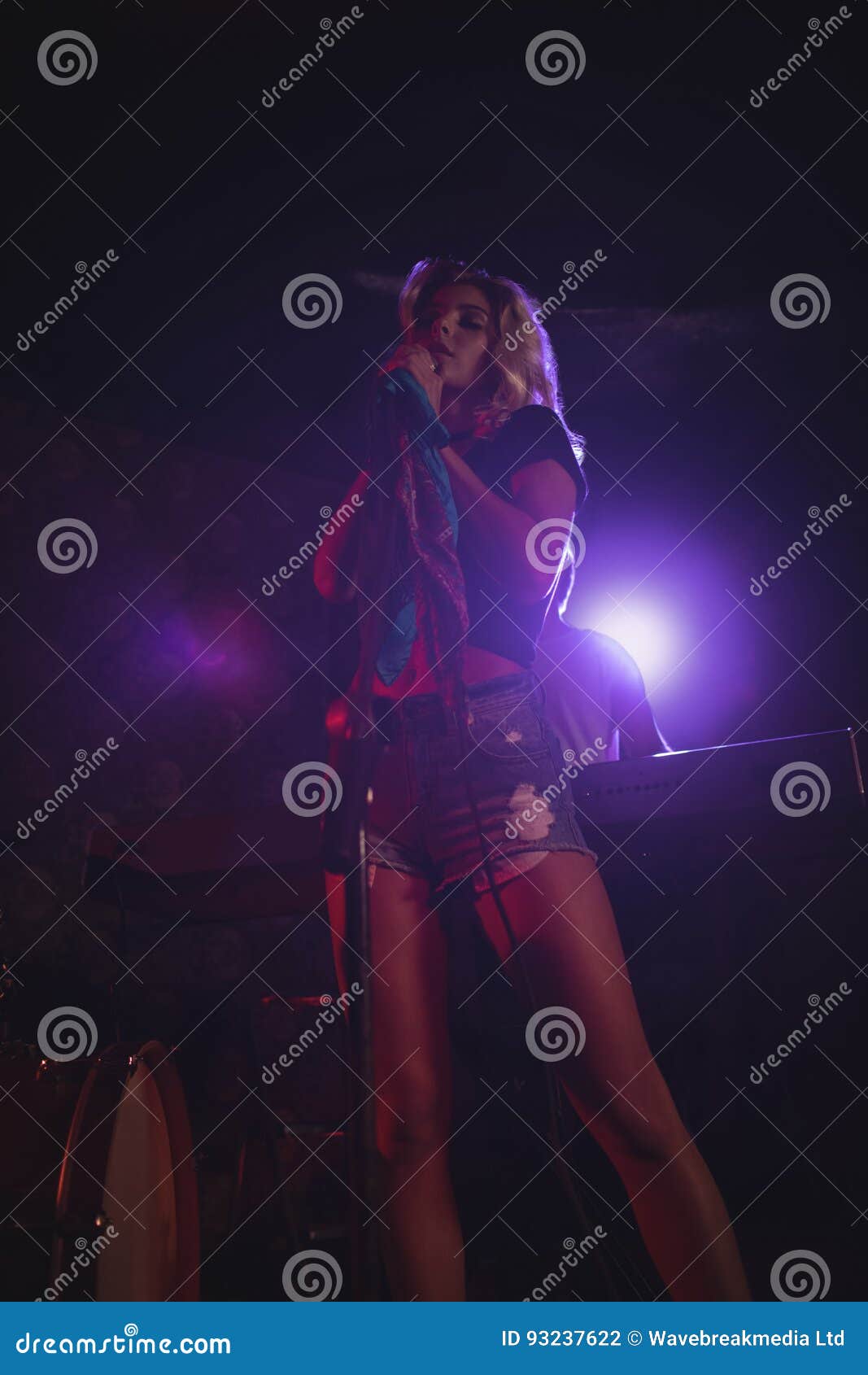 Female Singer Standing on Illuminated Stage in Nightclub Stock Photo ...