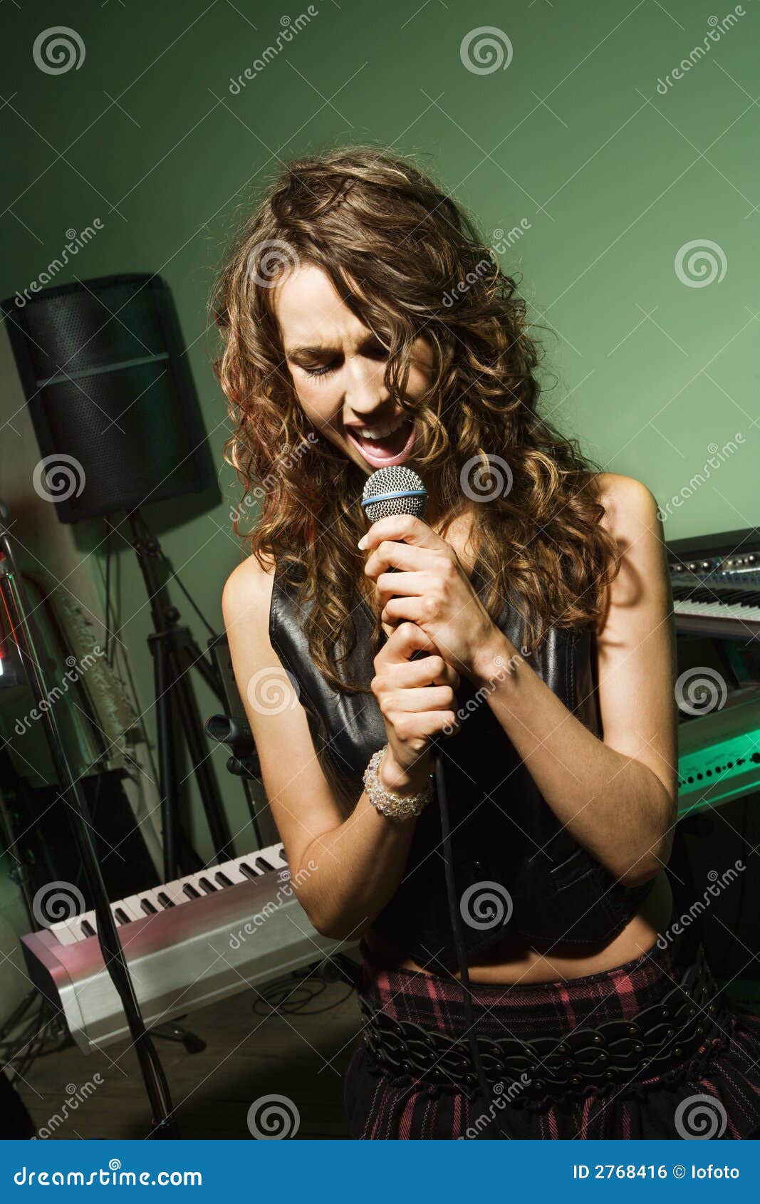 Female singing into mic. stock photo. Image of microphone - 2768416