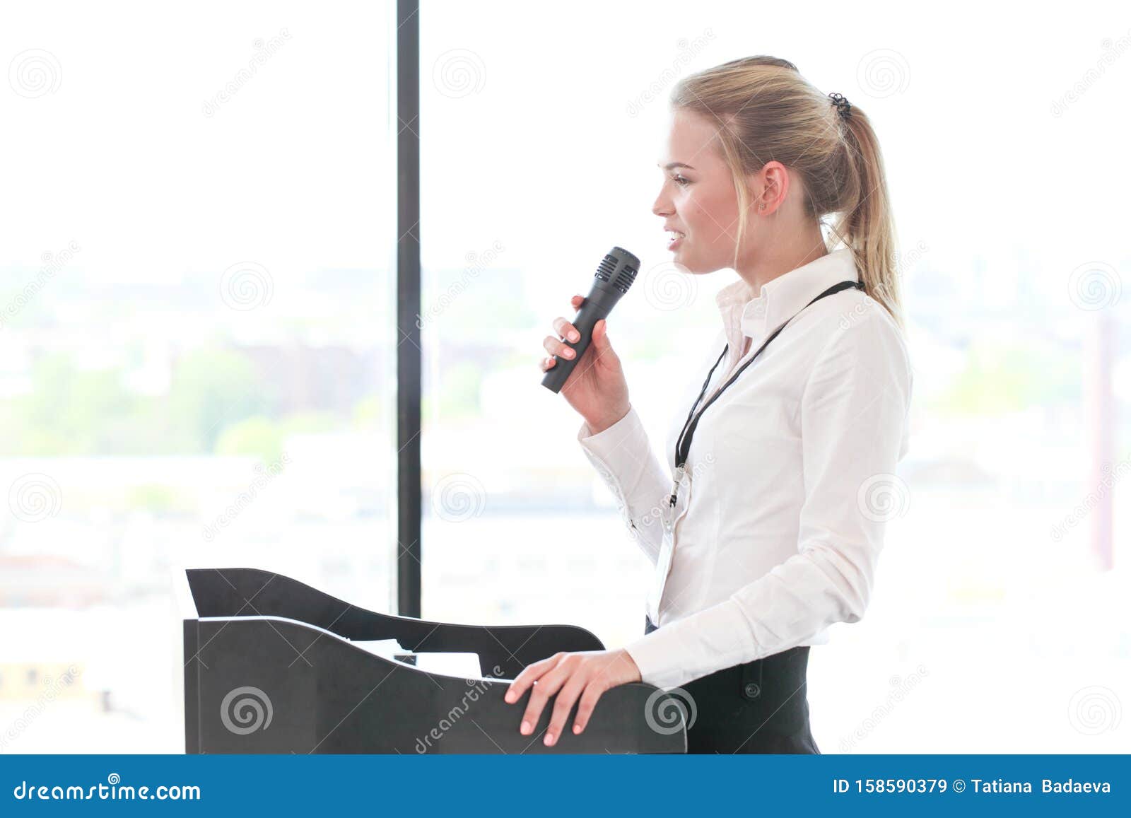 Female Speaker Giving Presentation In Hall At Workshop. Audience Or ...