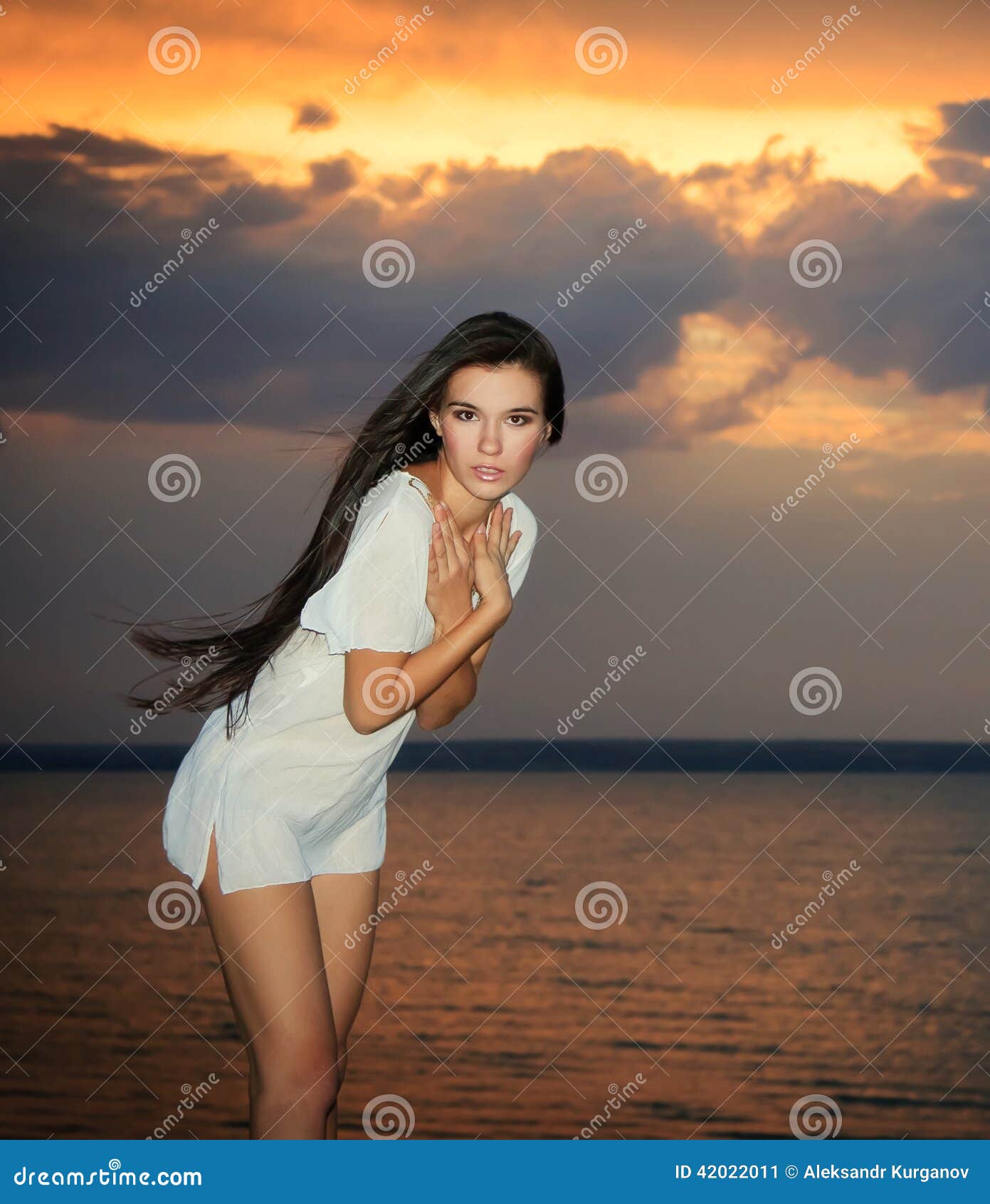 Female Standing Near Ocean in Rays of Sunset Stock Image - Image of ...