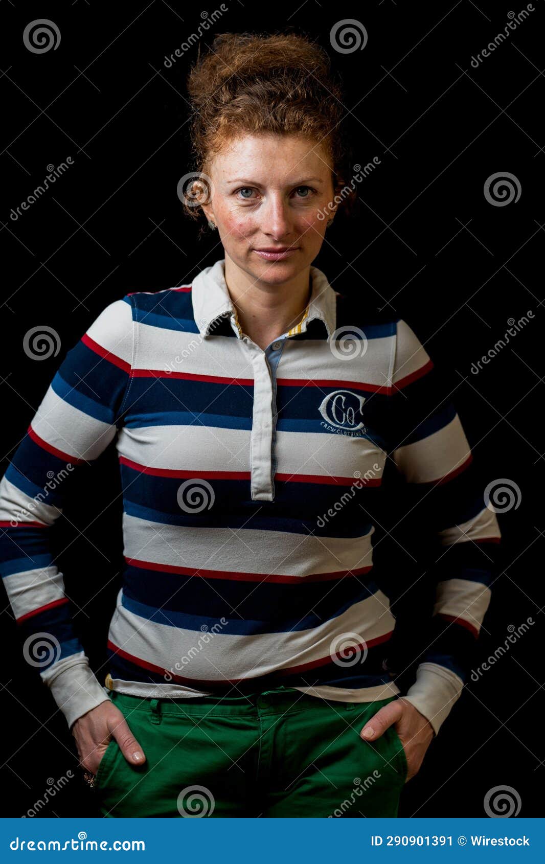 Female Standing in a Shadowy Space Arms Akimbo in a Confident Posture ...