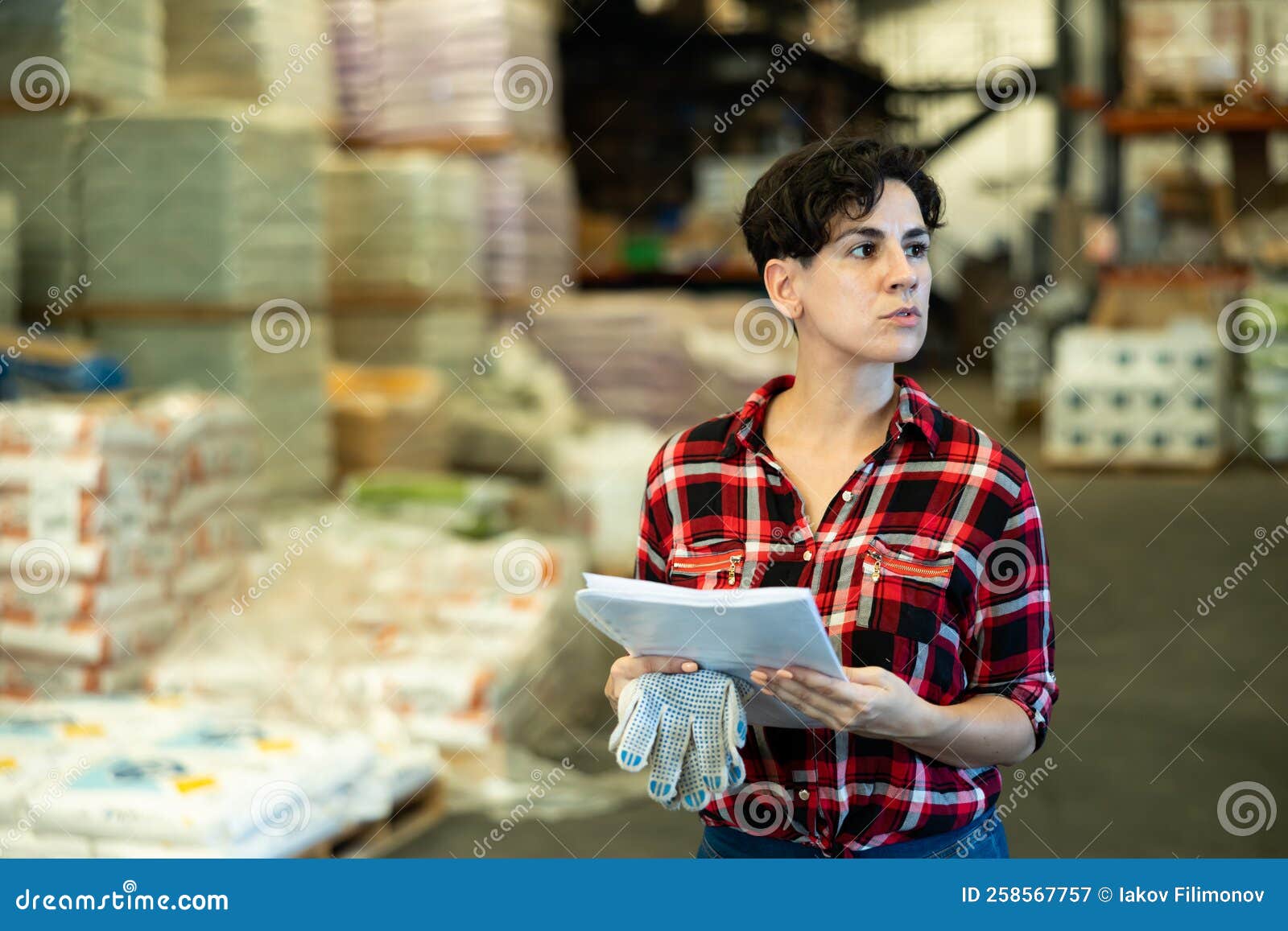 Female Storekeeper Checks Availability of Goods with Documents in the ...