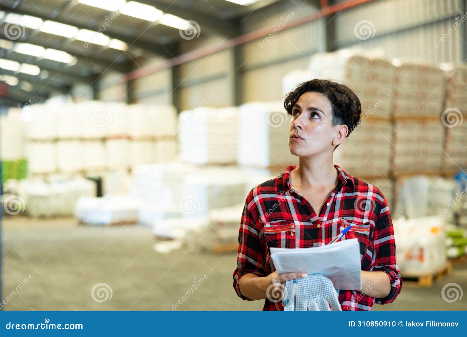 Female Storekeeper Checks Availability of Goods with Documents in the ...