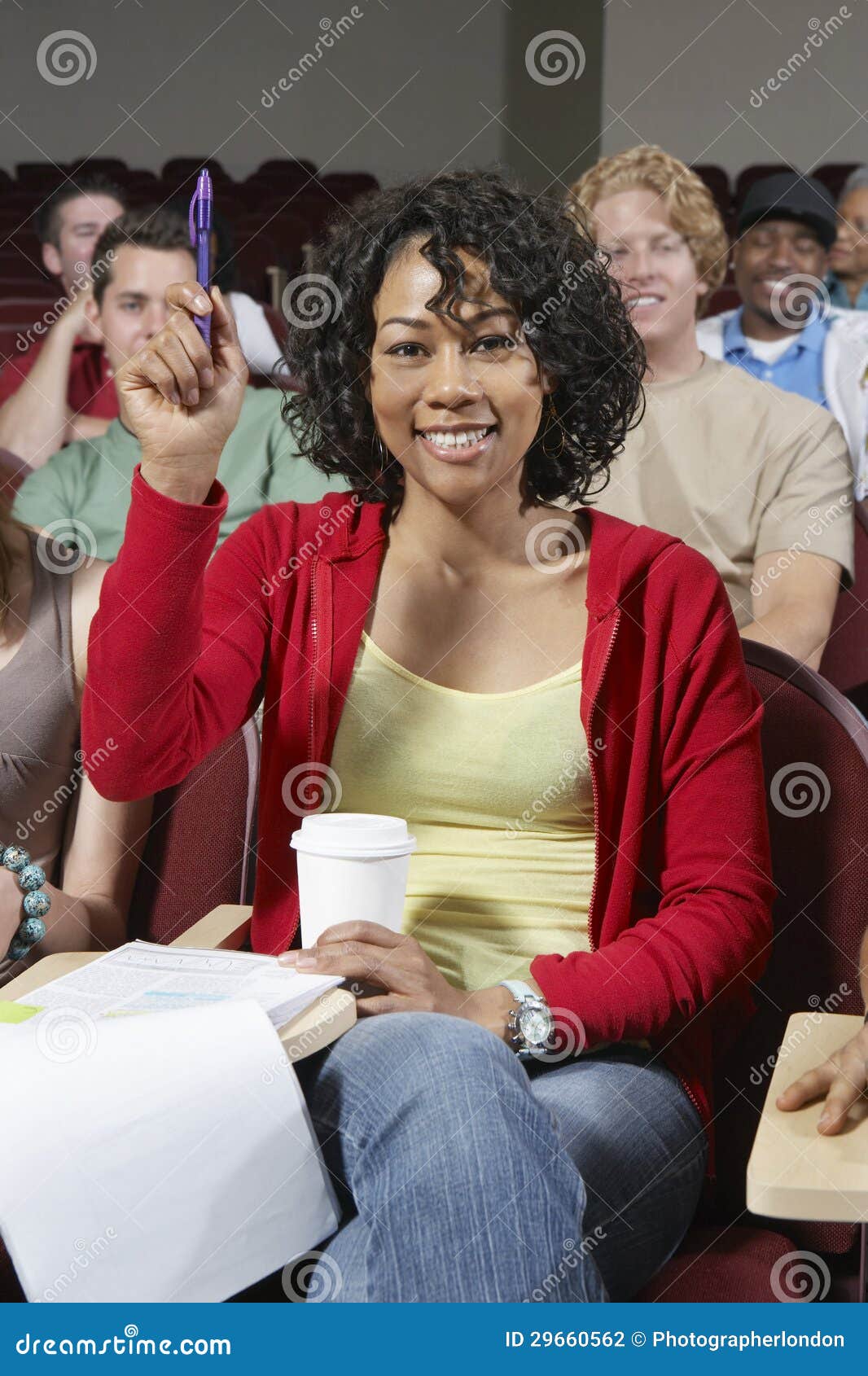 Female Student Answering in Class Stock Photo - Image of holding, glass ...