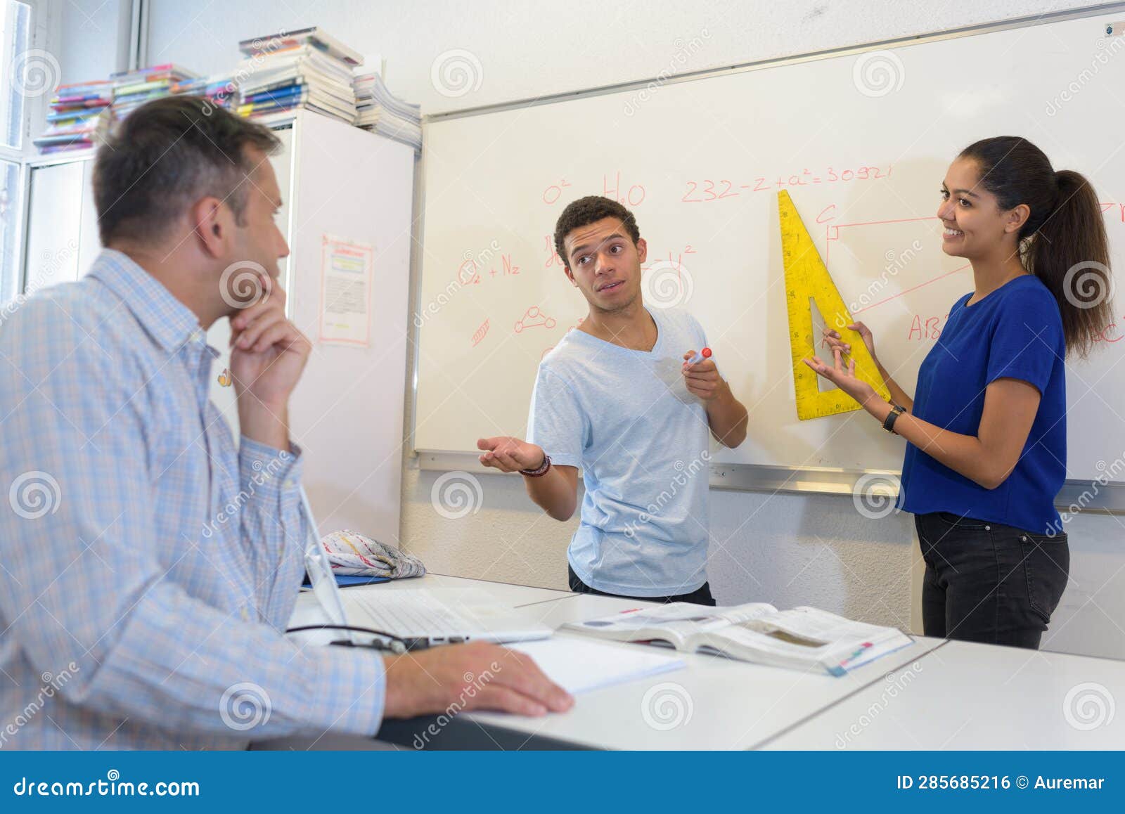 Female Student Answering Teachers Questions Stock Photo - Image of ...