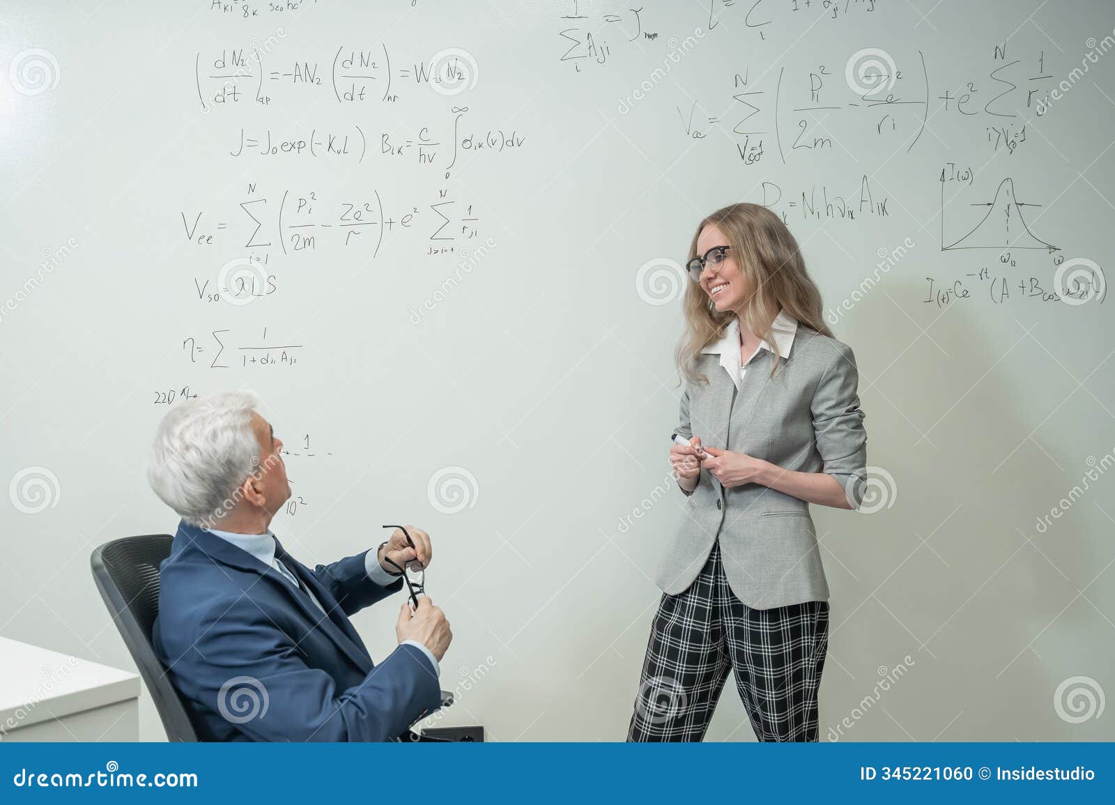 Female Student Answers a Question from an Elderly Professor at a White ...
