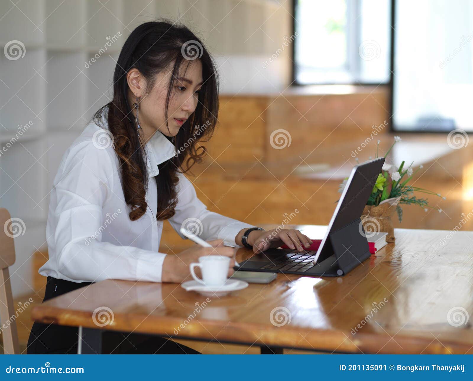 Female Student Doing Assignment with Tablet on Wooden Table in Cafe ...