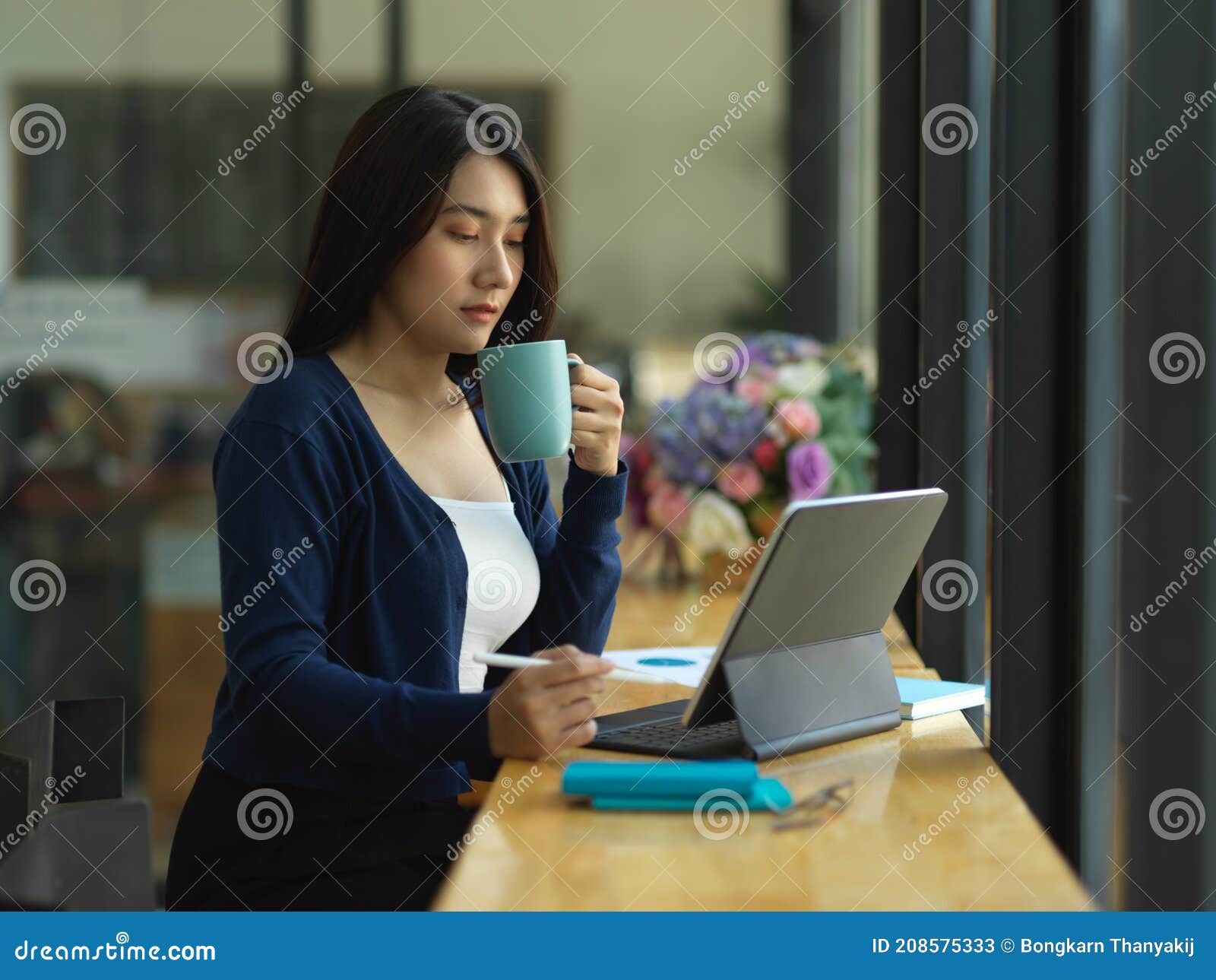 Female Student Drinking Coffee while Doing Homework with Digital Tablet ...