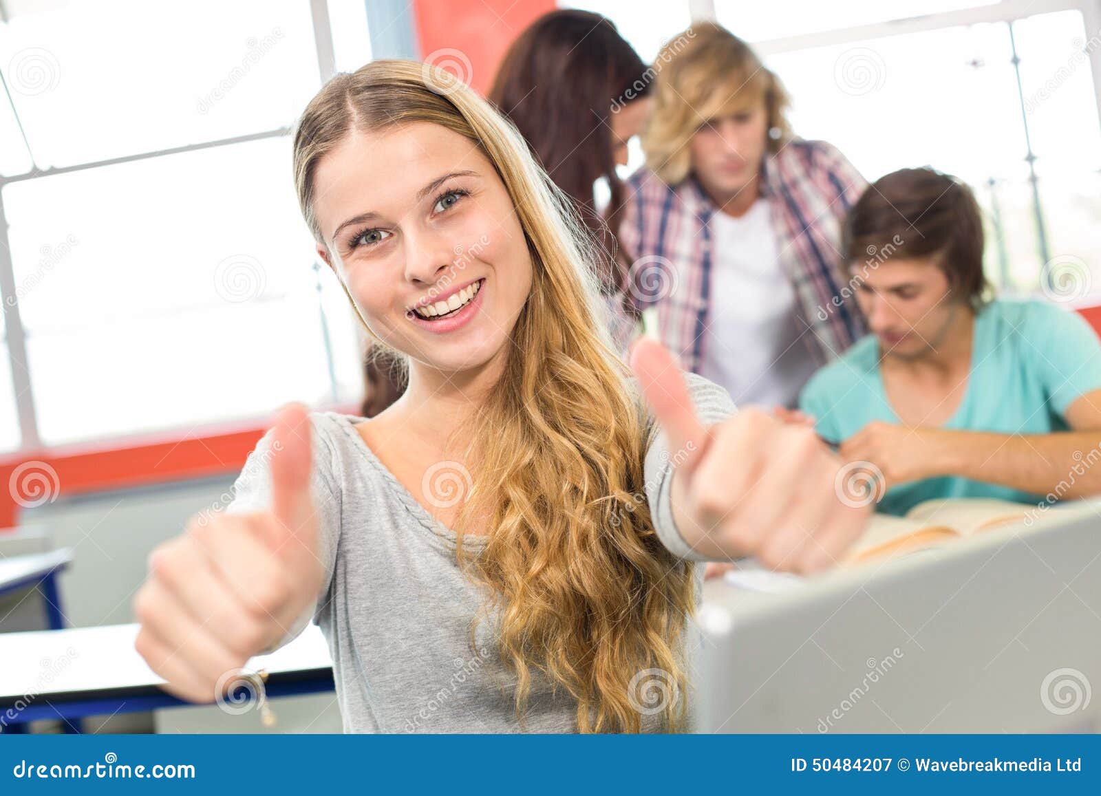 Female Student Gesturing Thumbs Up in Classroom Stock Image - Image of ...