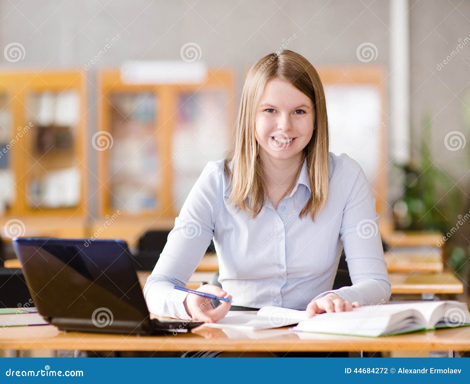 Female Student with Laptop Working in Library. Looking at Camera Stock ...