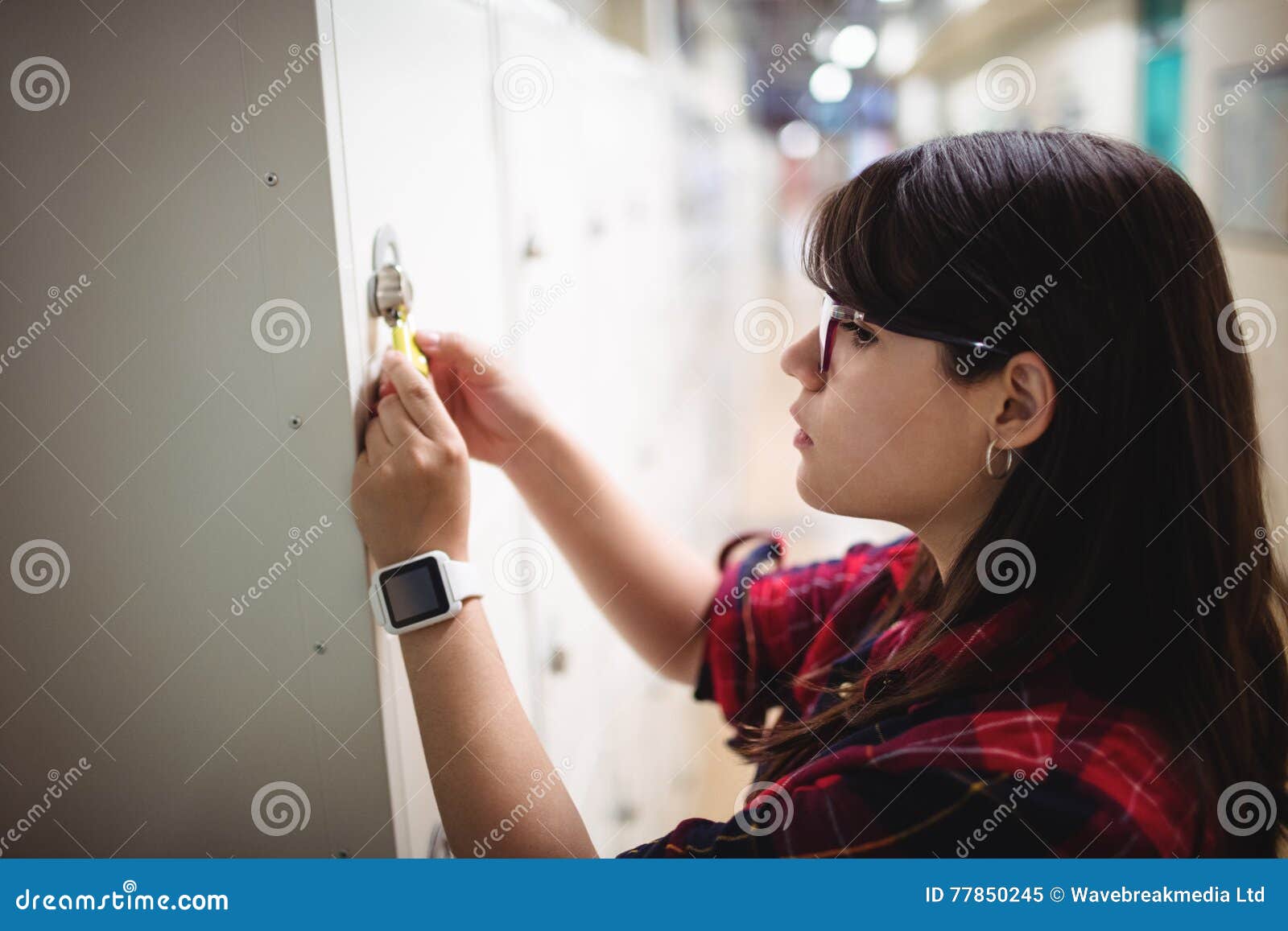 Female Student Locking Her Locker Stock Image - Image of concentration ...