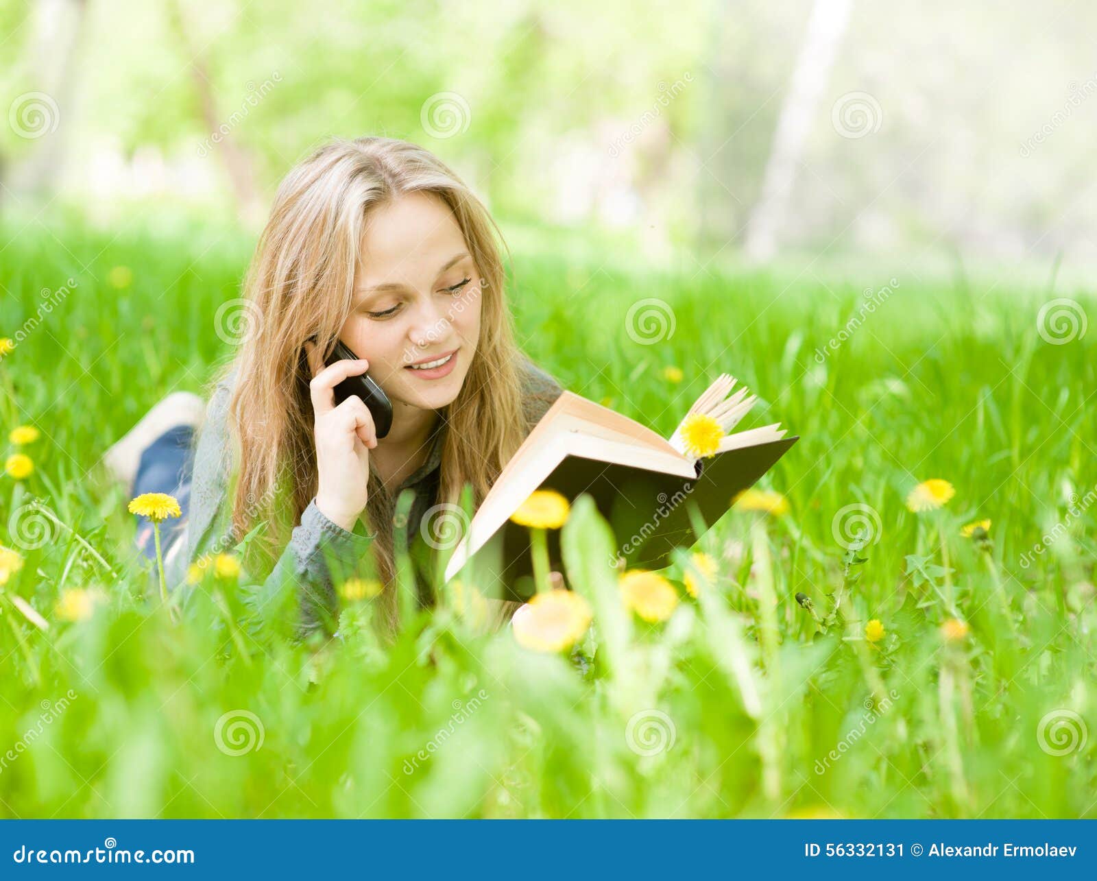 Female Student Lying on Grass Reading a Book and Talking on the Green ...