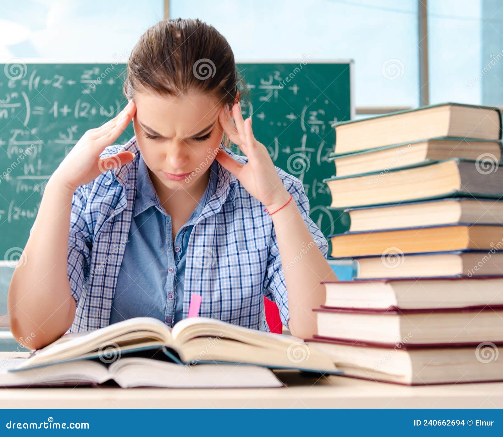 The Female Student with Many Books Sitting in the Classroom Stock Photo ...