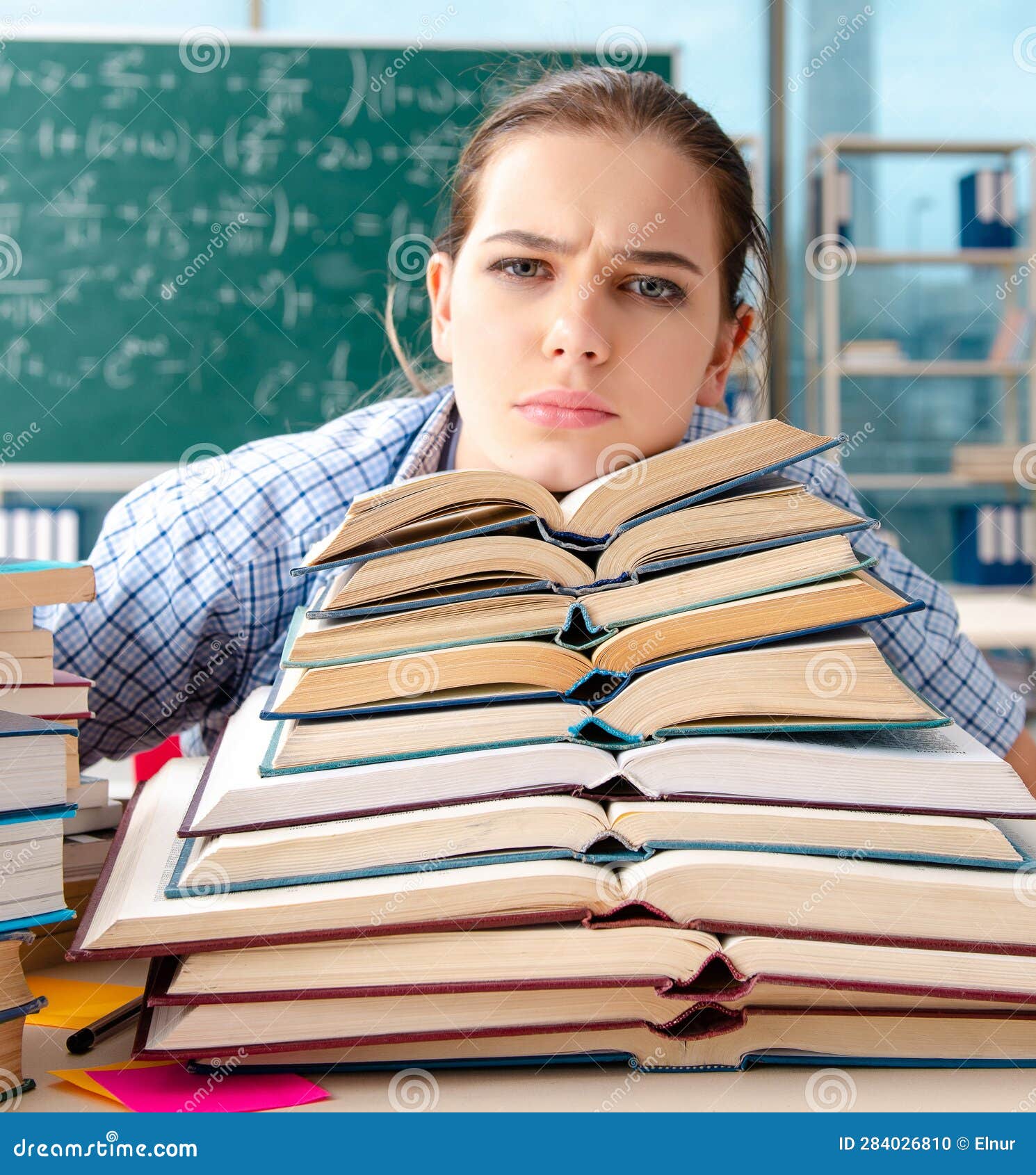 Female Student with Many Books Sitting in the Classroom Stock Photo ...
