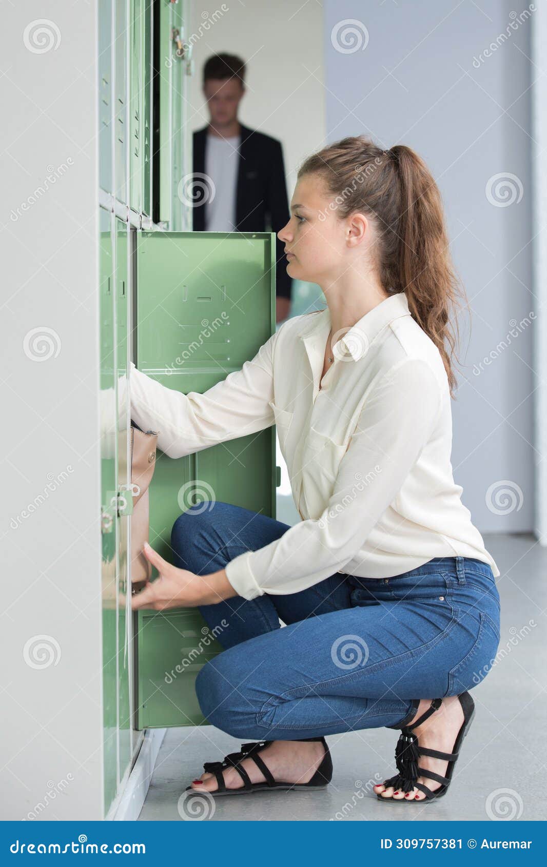 Female Student Opening Locker at University Stock Image - Image of ...