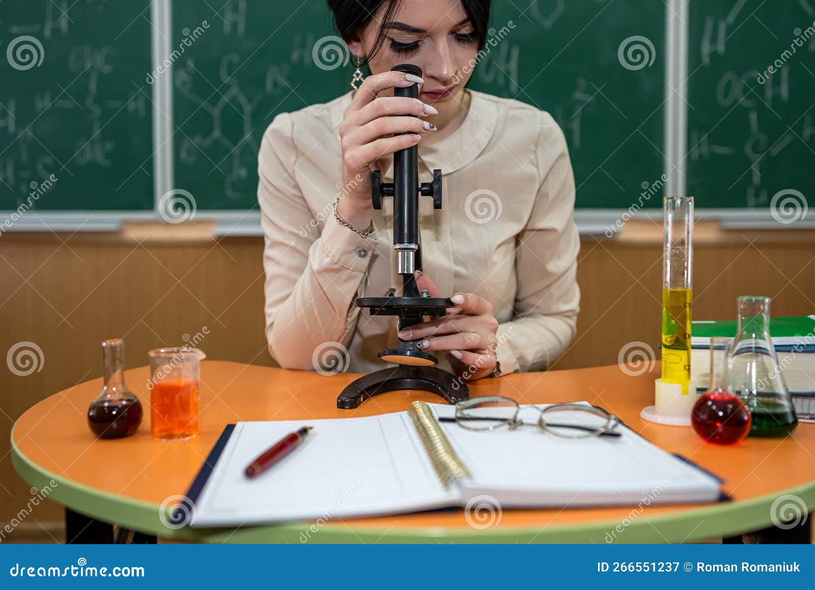 Female Student is Practicing in a Chemistry Classroom with Flasks on of ...