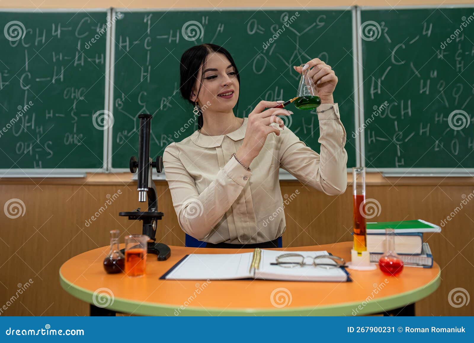 Female Student is Practicing in a Chemistry Classroom with Flasks on of ...