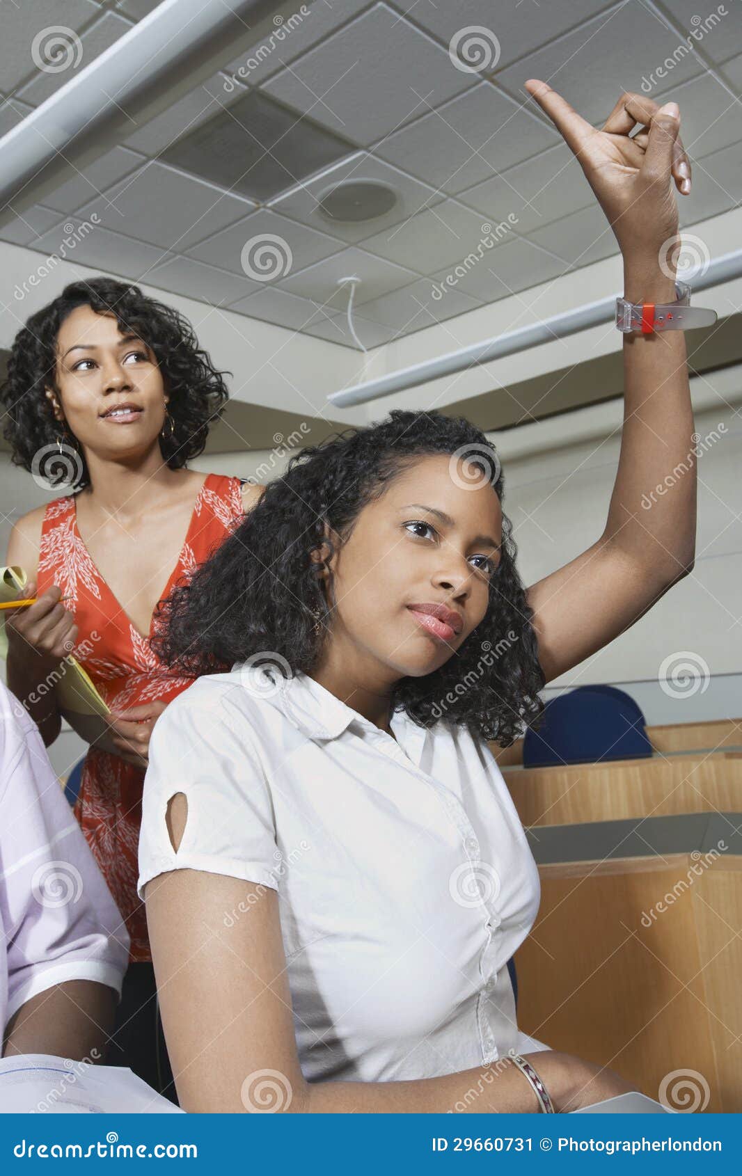 Female Student Raising Hand in Class Stock Image - Image of college ...