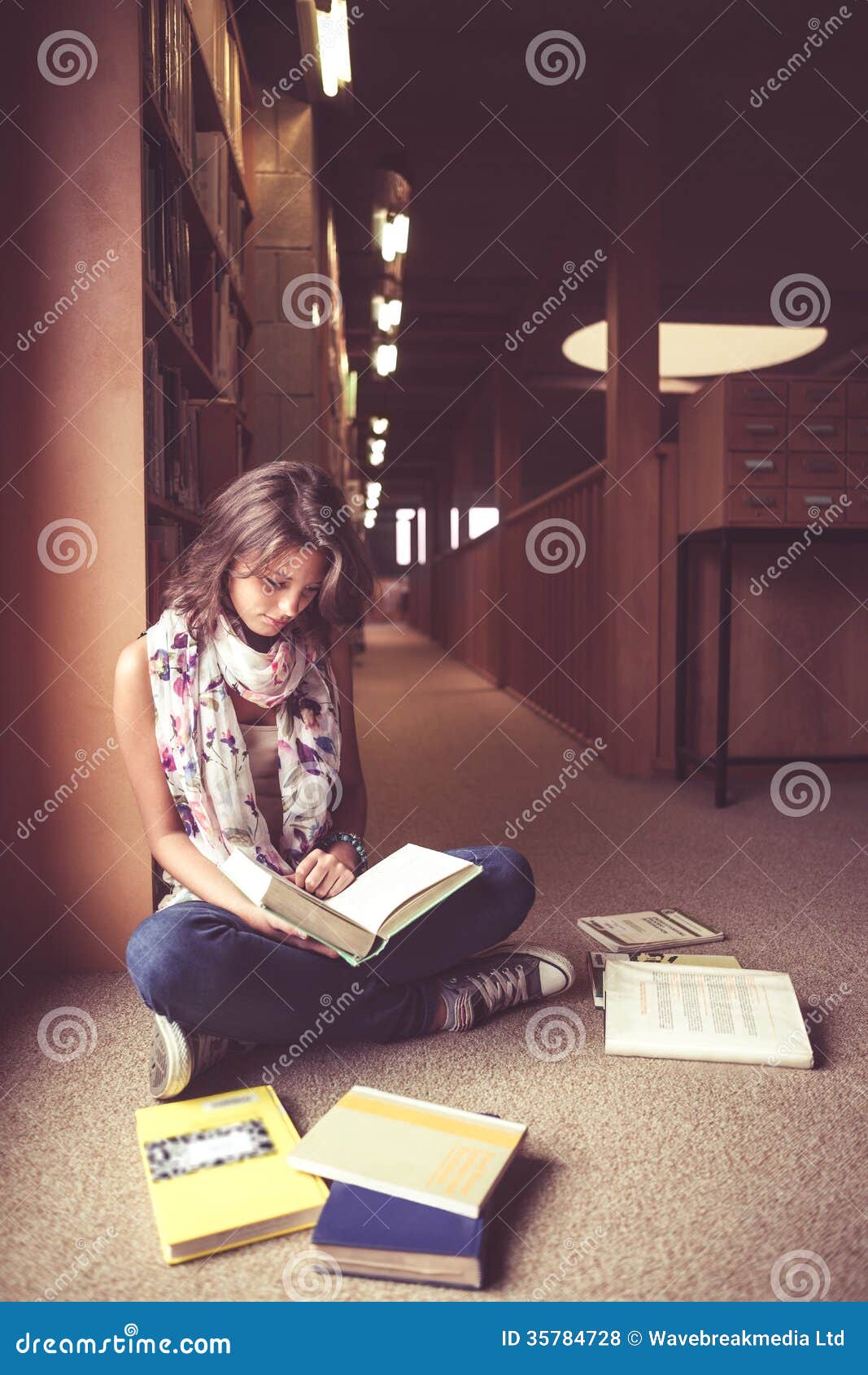 Female Student Reading a Book in the Library Aisle Stock Photo - Image ...