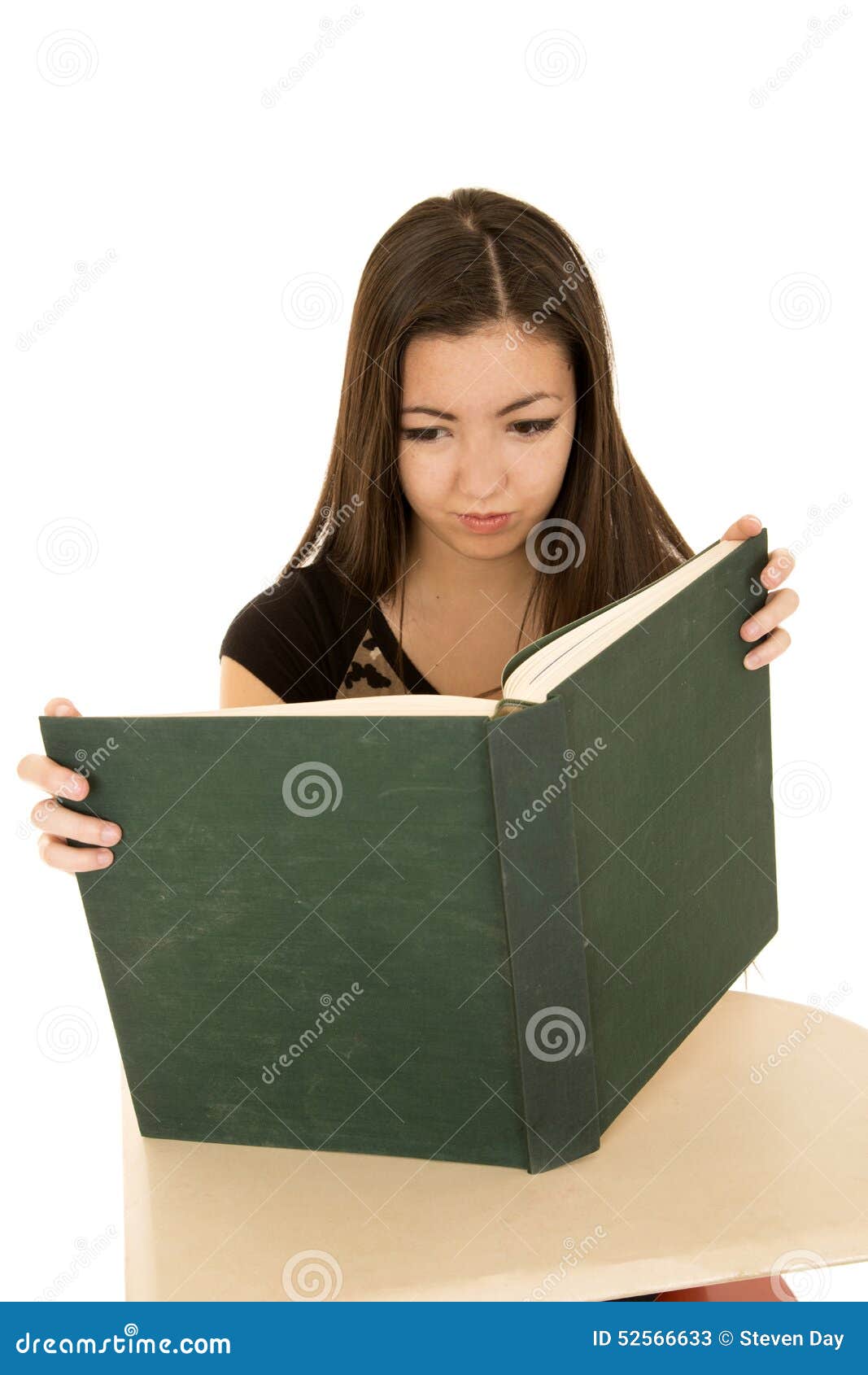 Female Student Reading a Large Book at a School Desk Stock Image ...