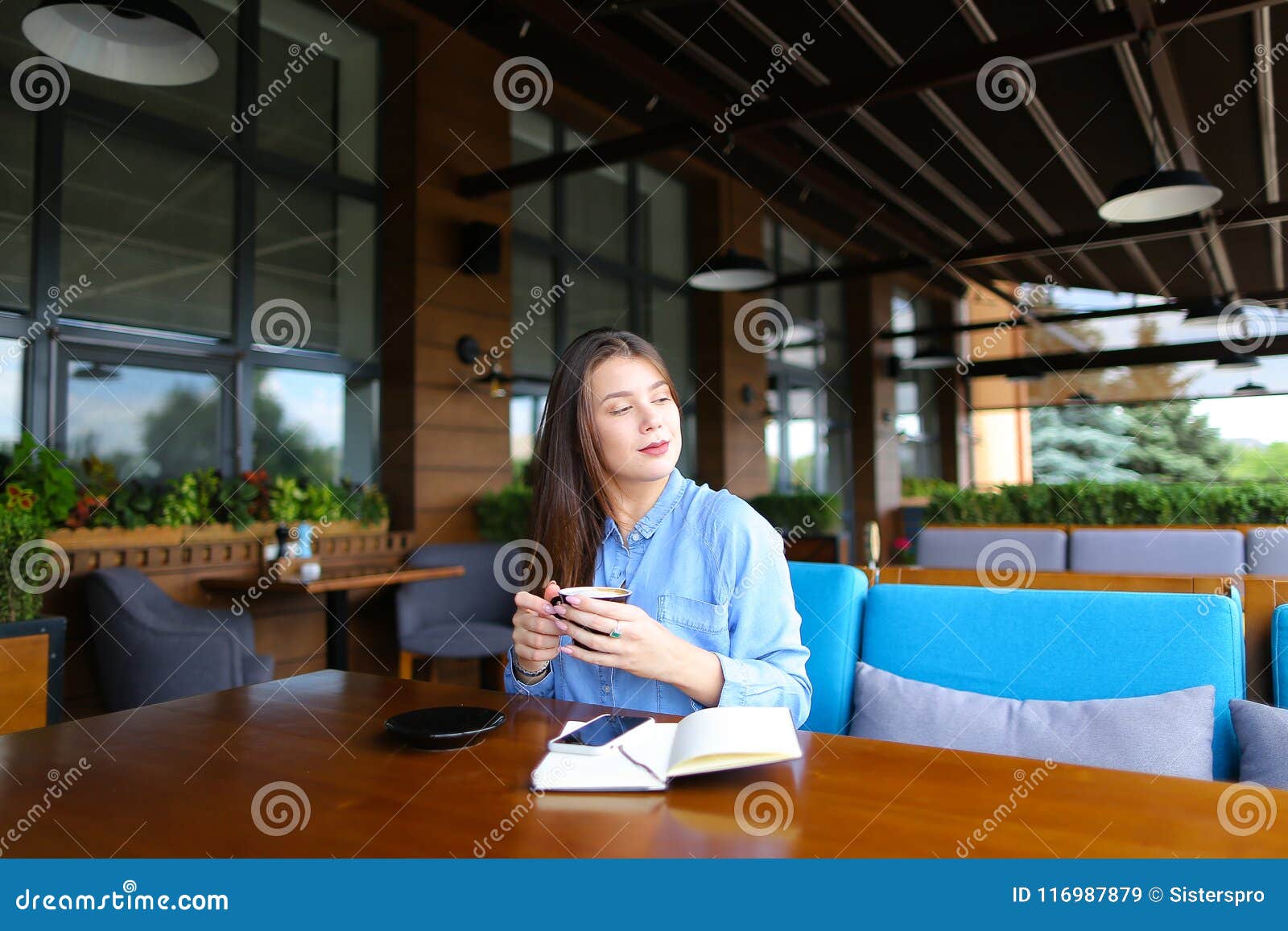 Female Student Resting at Cafe with Smartphone, Notebook and Cup of ...