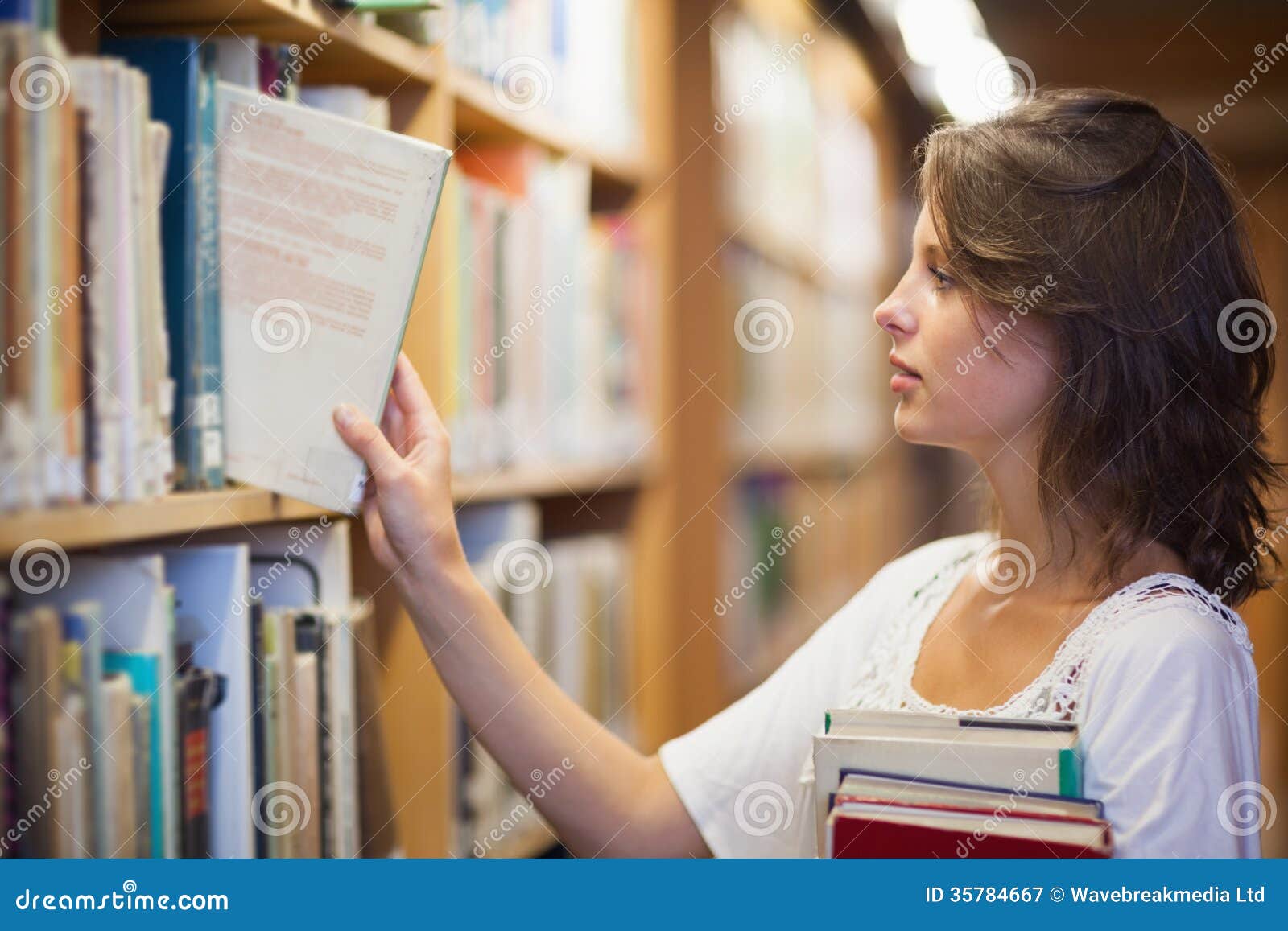 Female Student Selecting Book in the Library Stock Image - Image of ...