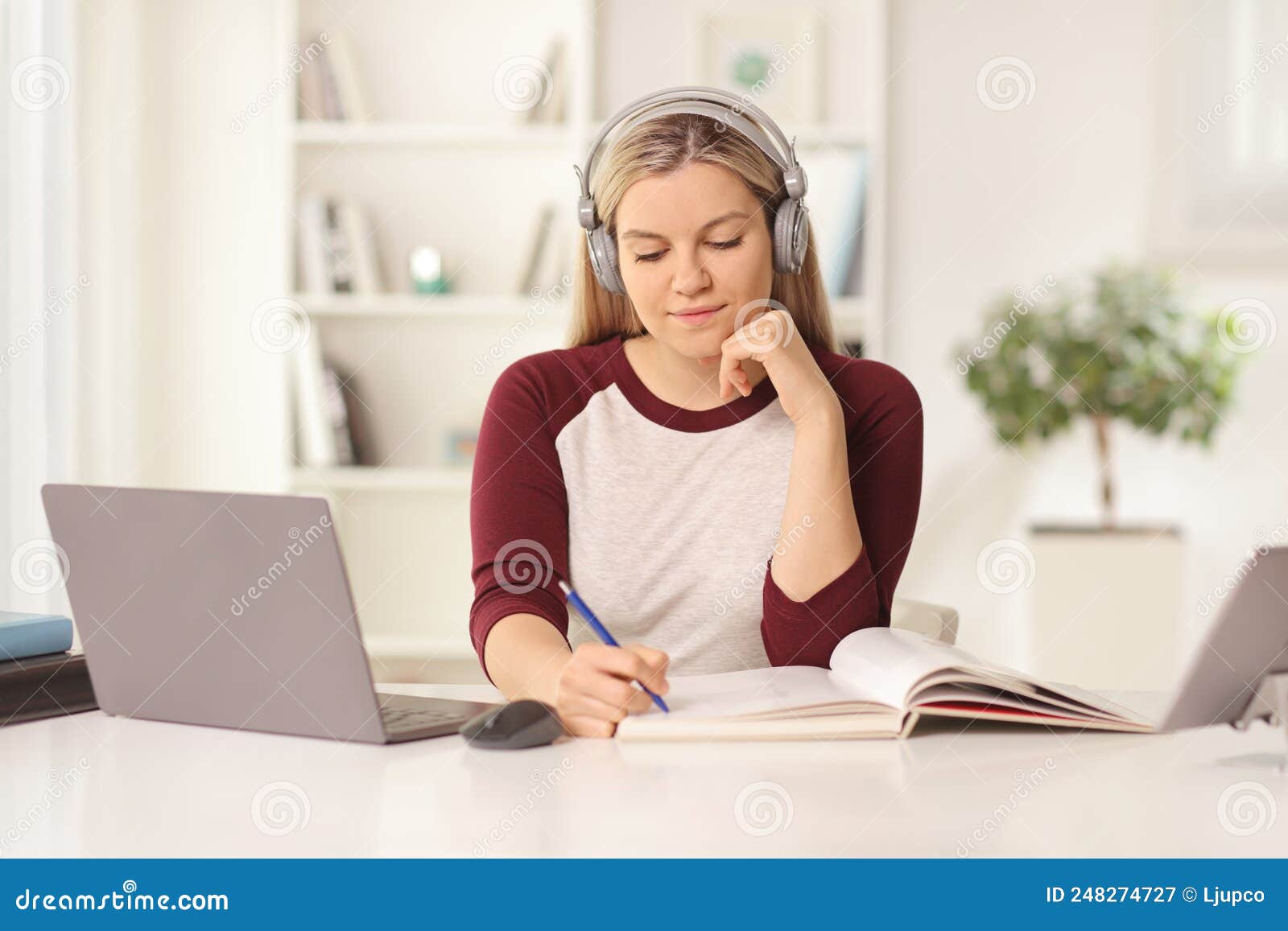Female Student Sitting in Front of a Laptop Computer at Home with ...