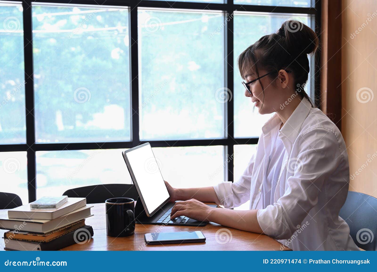 Female Student Sitting in Library and Using Laptop Computer. Stock ...