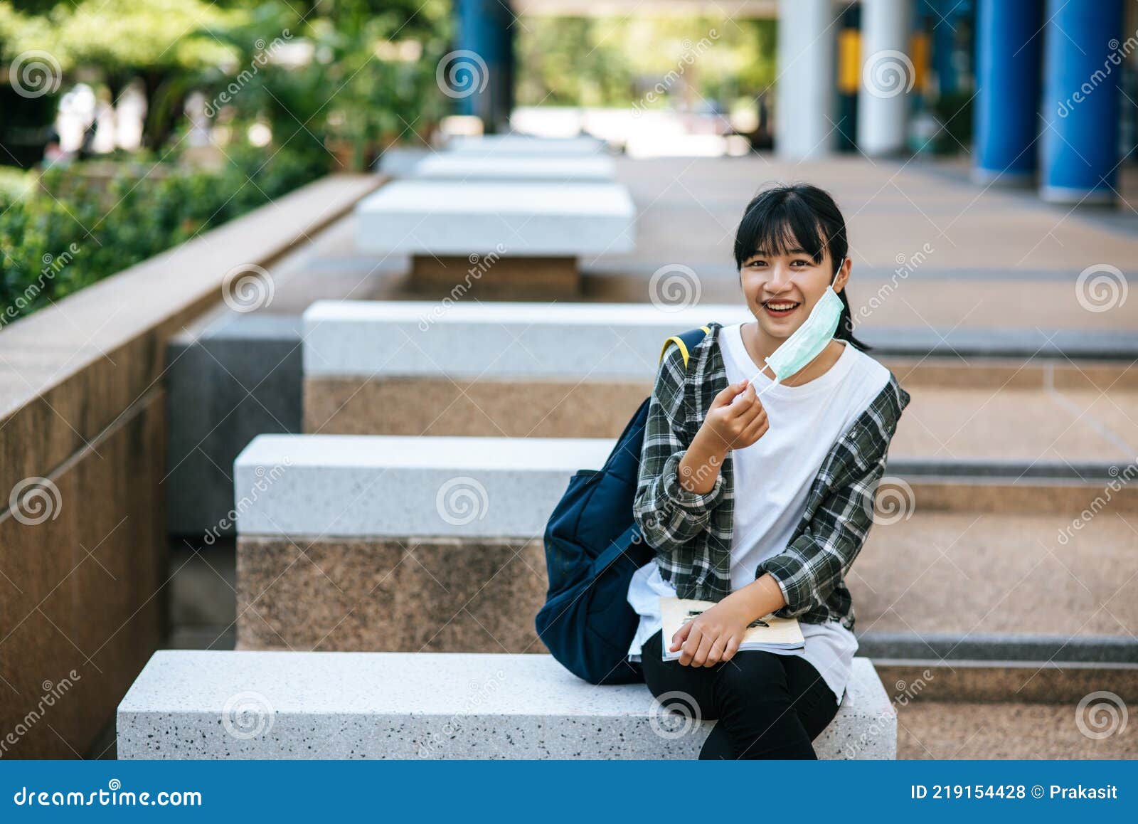 Female Student Sitting on the Stairs and Read a Book Stock Photo ...