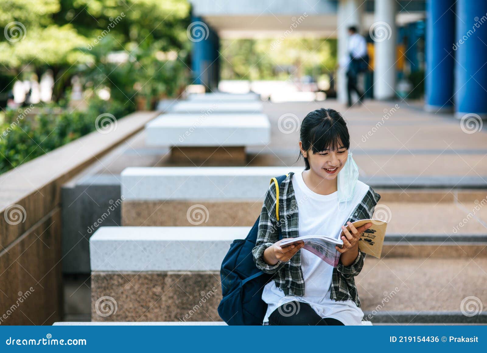 Female Student Sitting on the Stairs and Read a Book Stock Photo ...