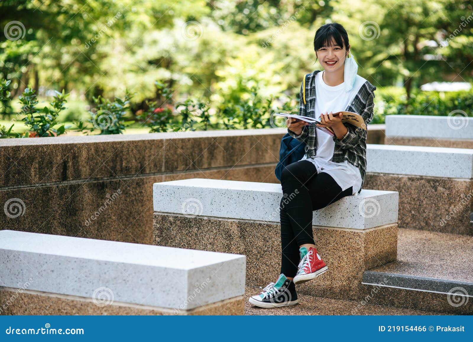 Female Student Sitting on the Stairs and Read a Book Stock Photo ...