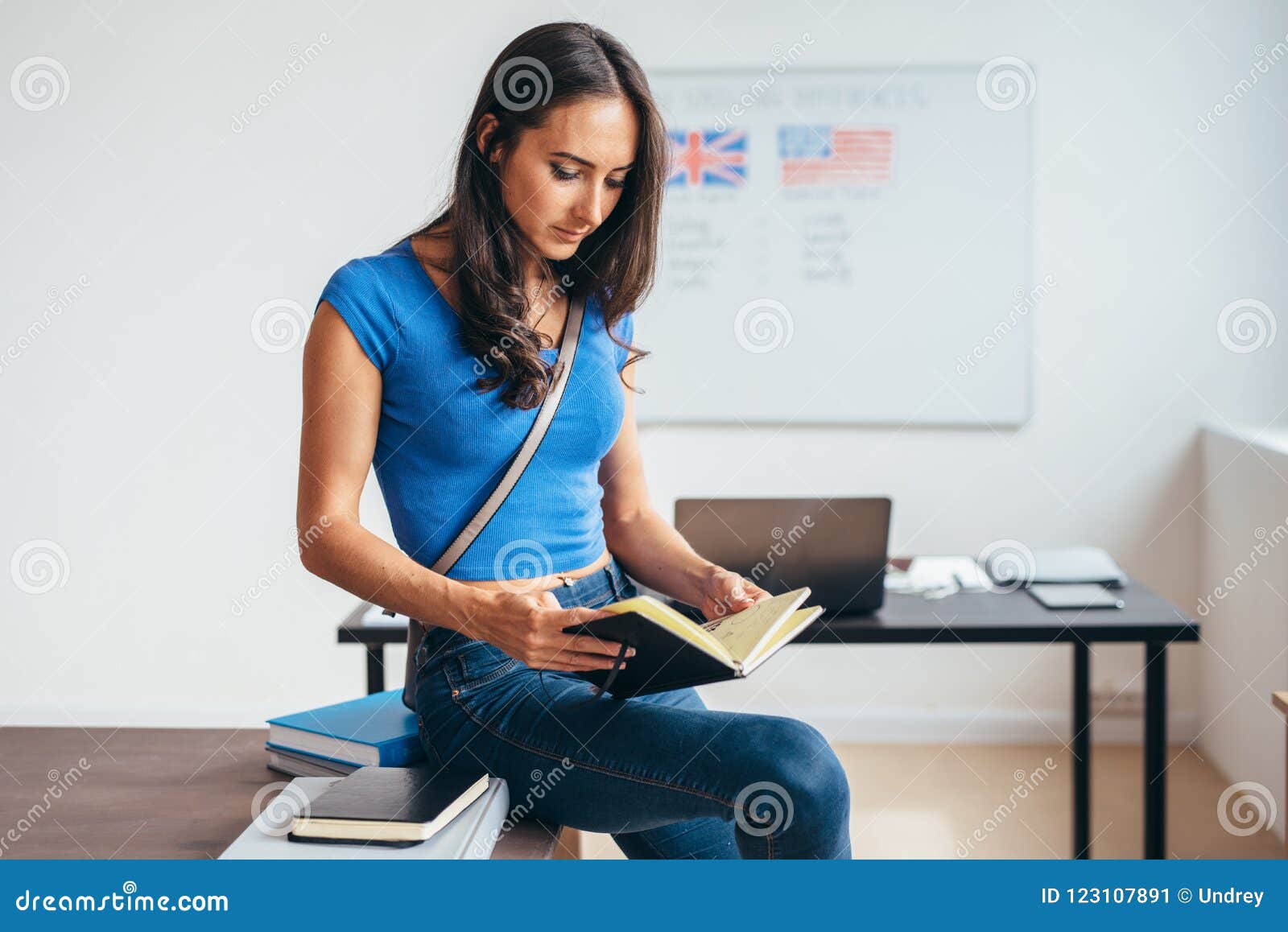 Female Student Sitting at Table and Read. Stock Image - Image of ...