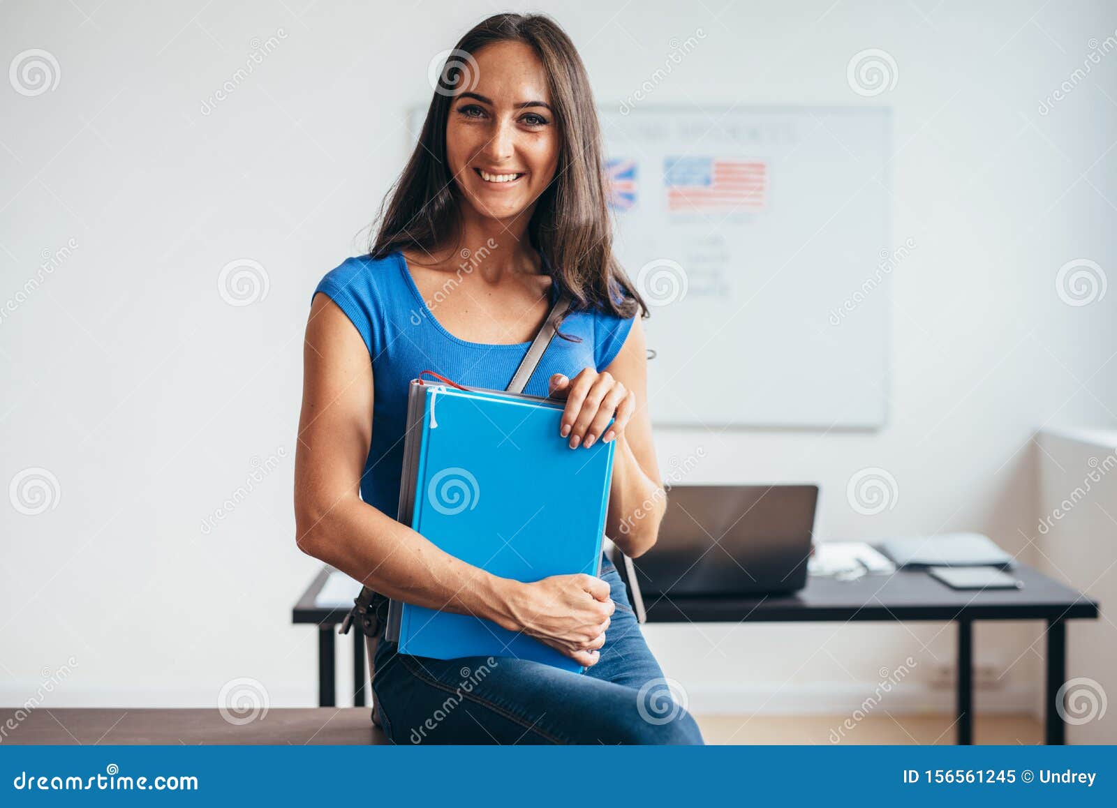 Female Student Sitting at Table Smiling and Looking at Camera. Stock ...