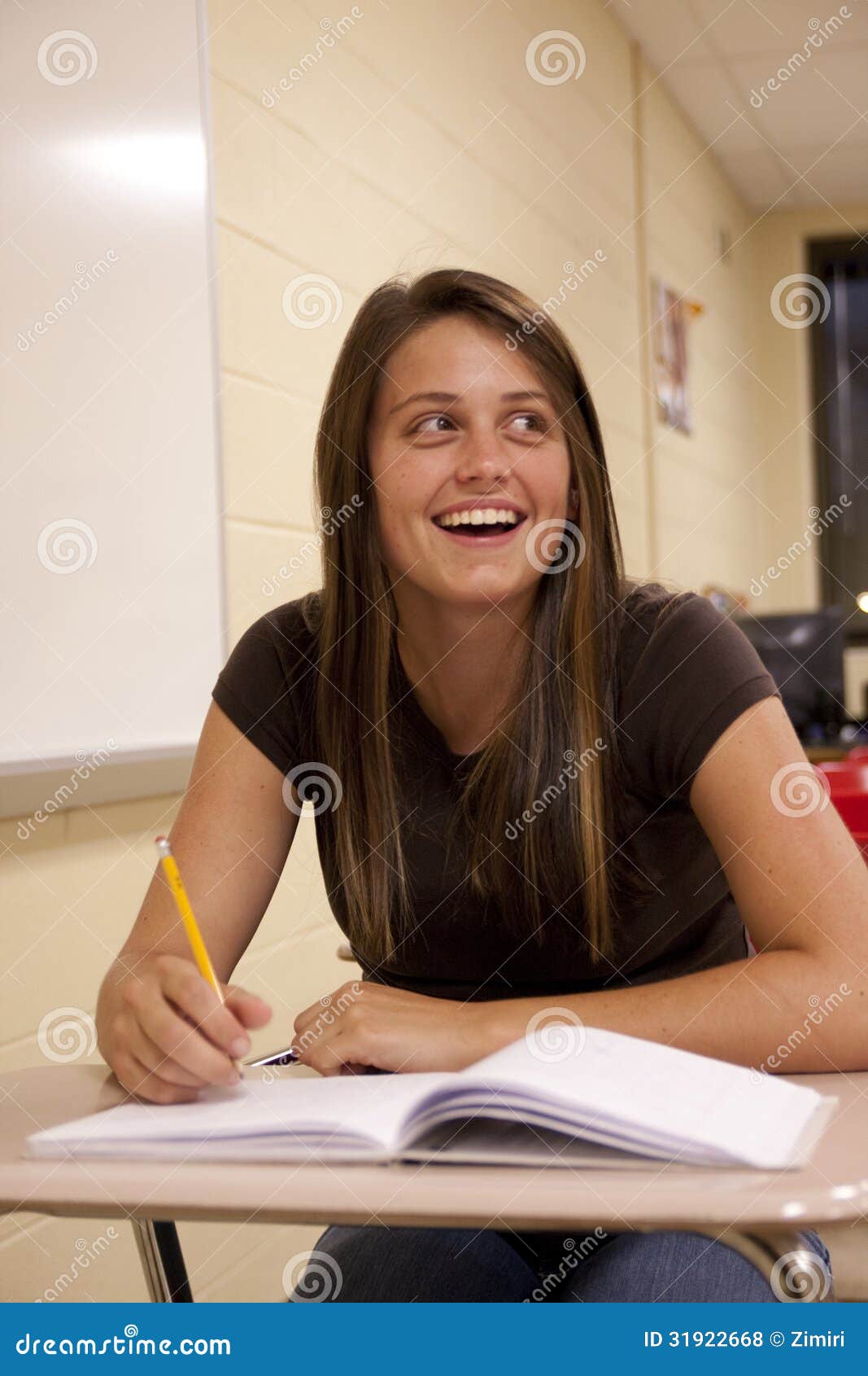 Female Student Smiling at Her Desk Stock Photo - Image of female ...