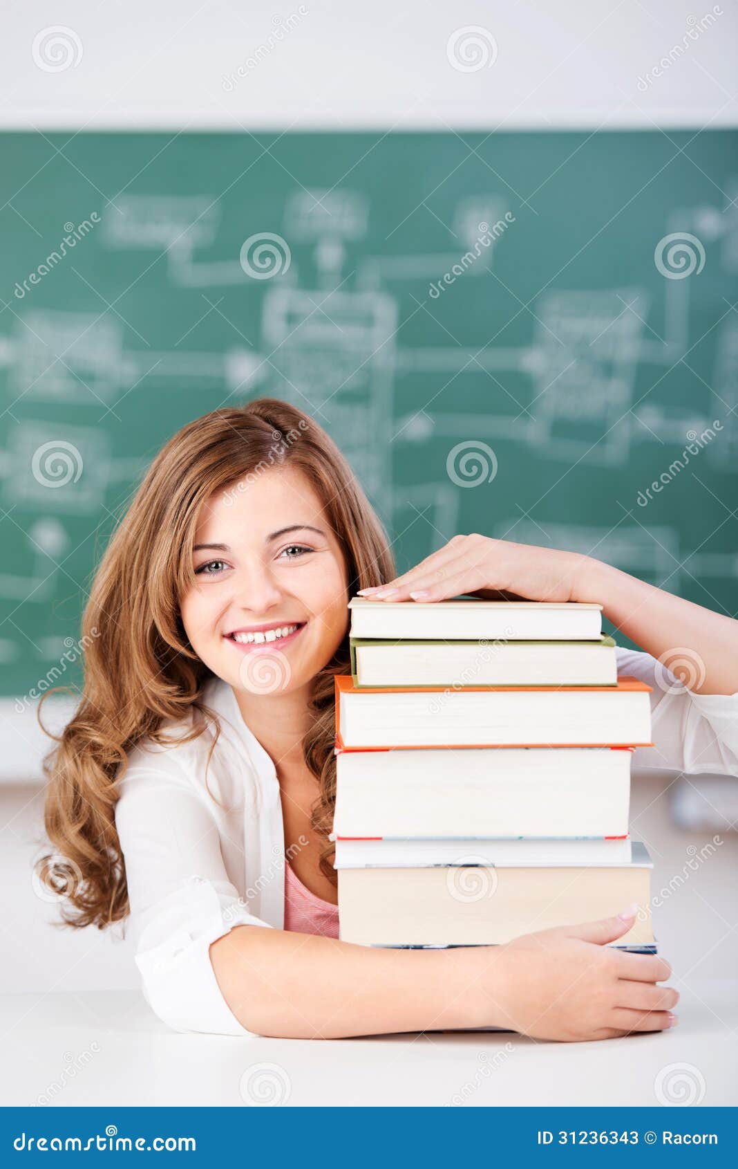 Female Student with Stack of Books at Table in Classroom Stock Image ...
