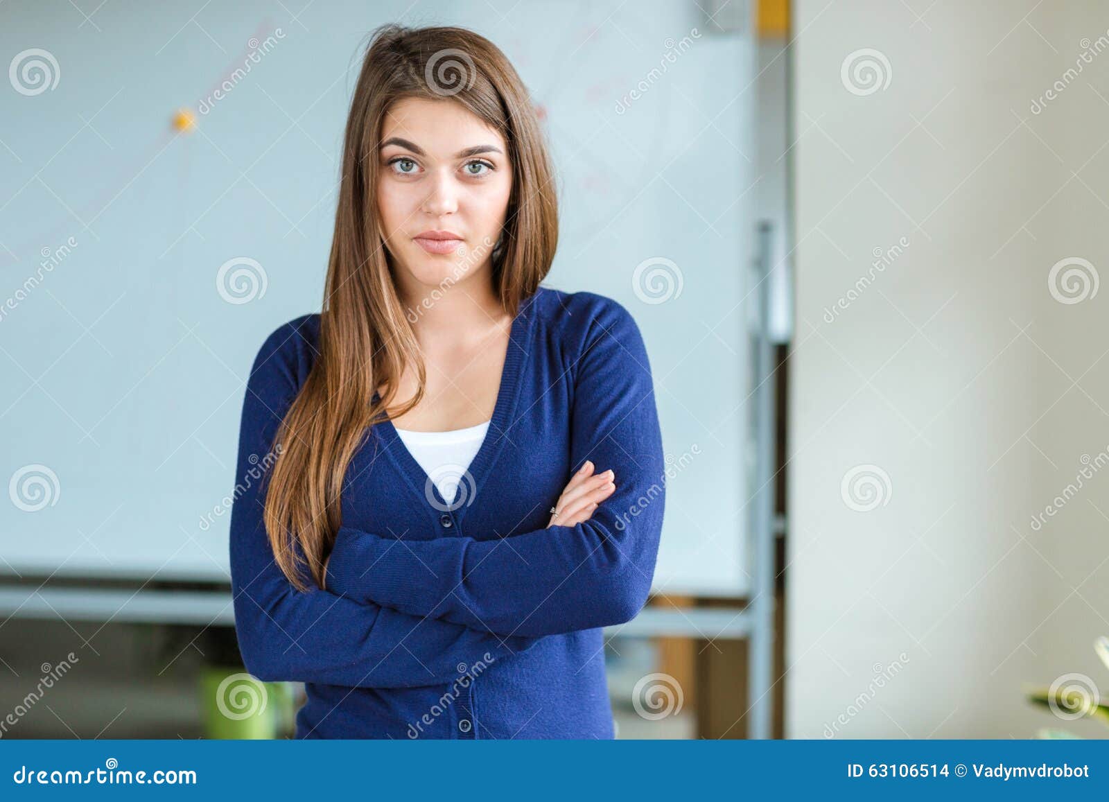 Female Student Standing with Arms Folded in University Stock Photo ...
