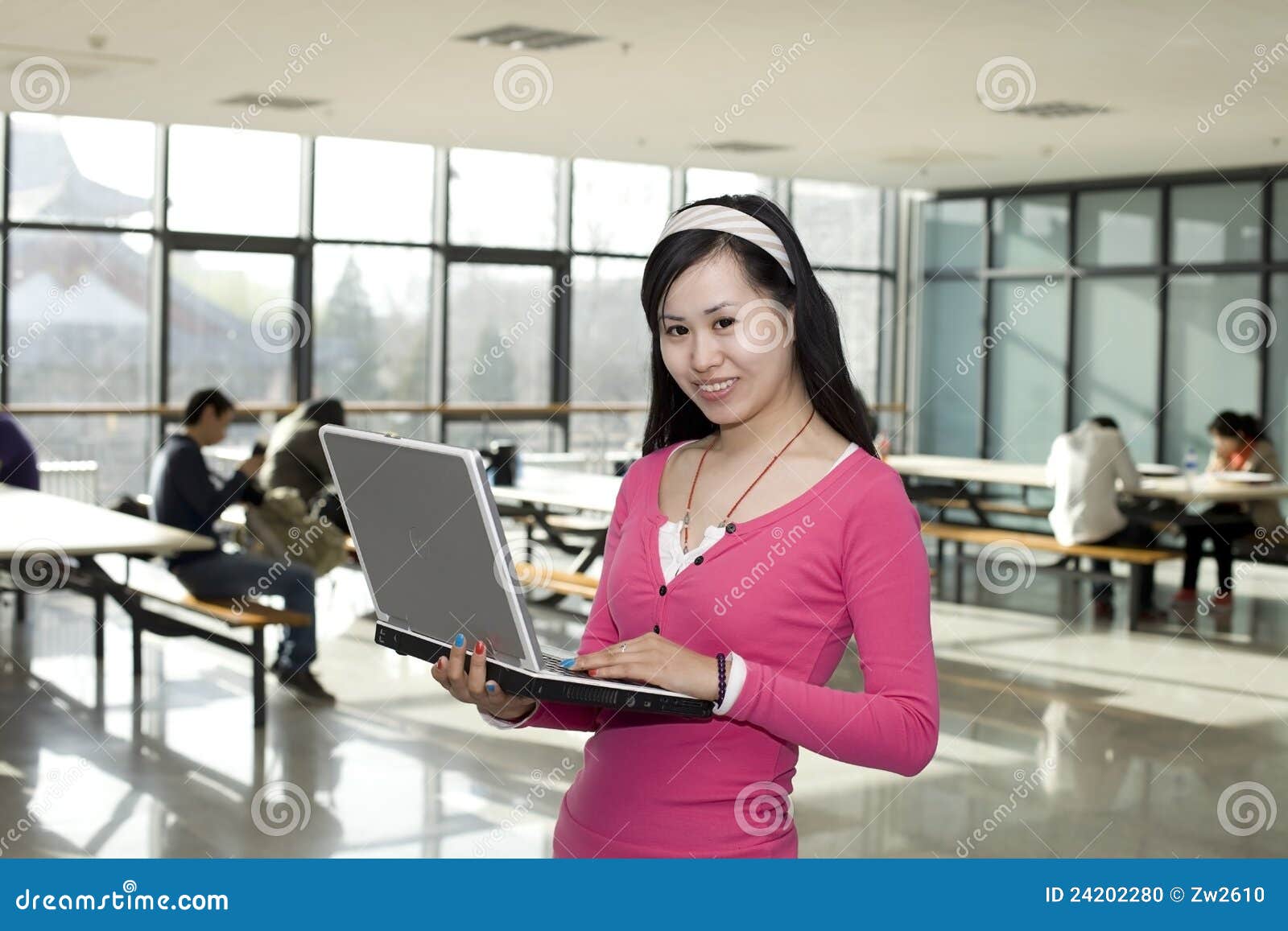 A Female Student Standing with a Computer Stock Photo - Image of glass ...