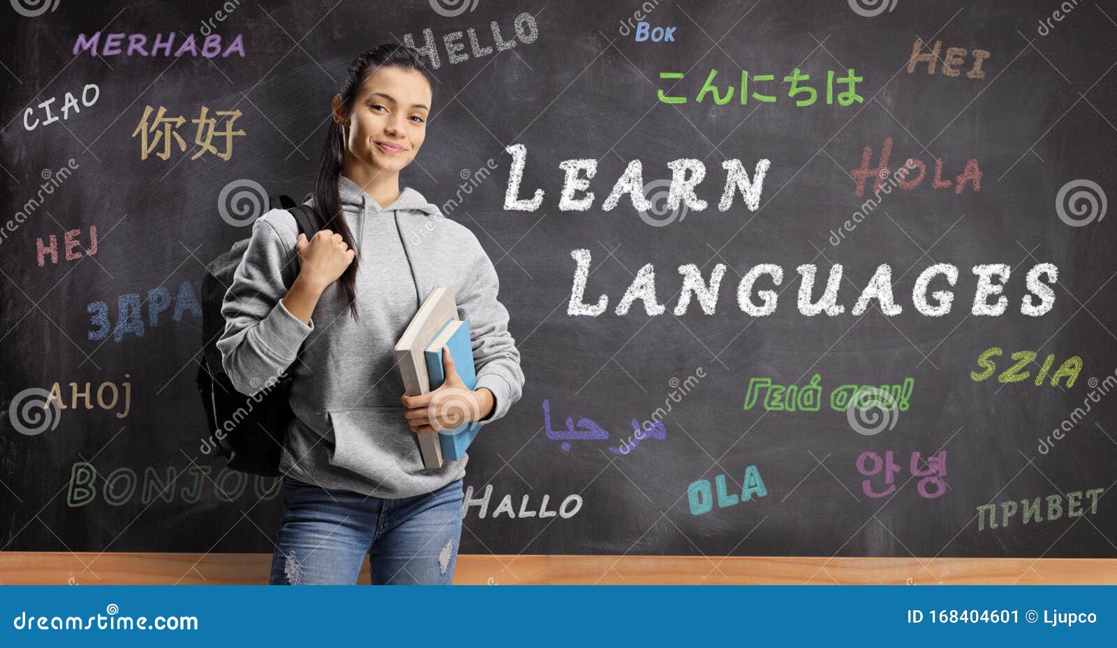 Female Student Standing in Front of a Blackboard with Hello Written in ...