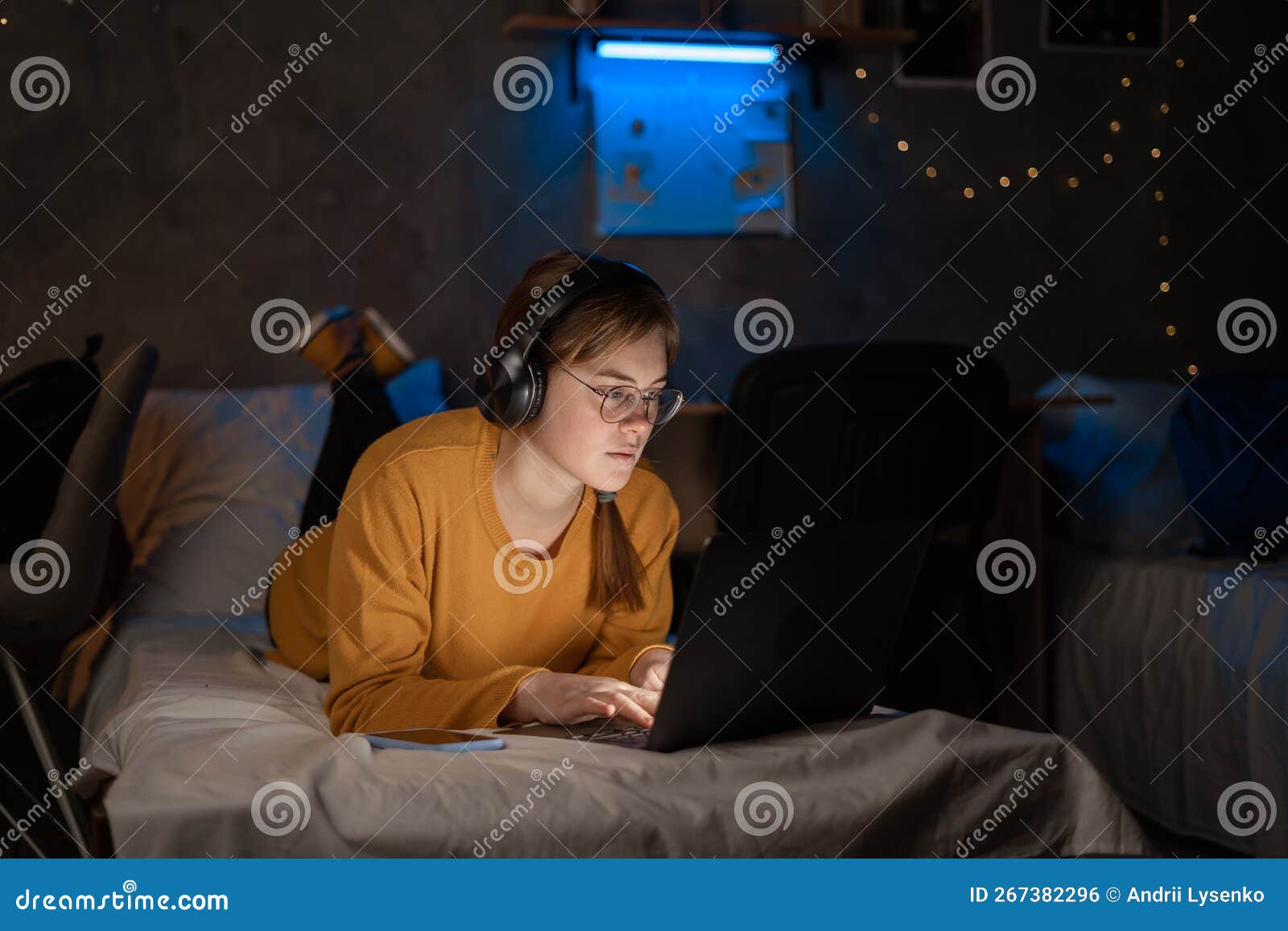 Female Student Studying at Night on Bed in Dorm Room Using Laptop ...