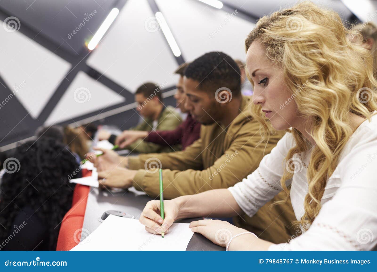 Female Student Taking Notes in a University Lecture Theatre Stock Image ...