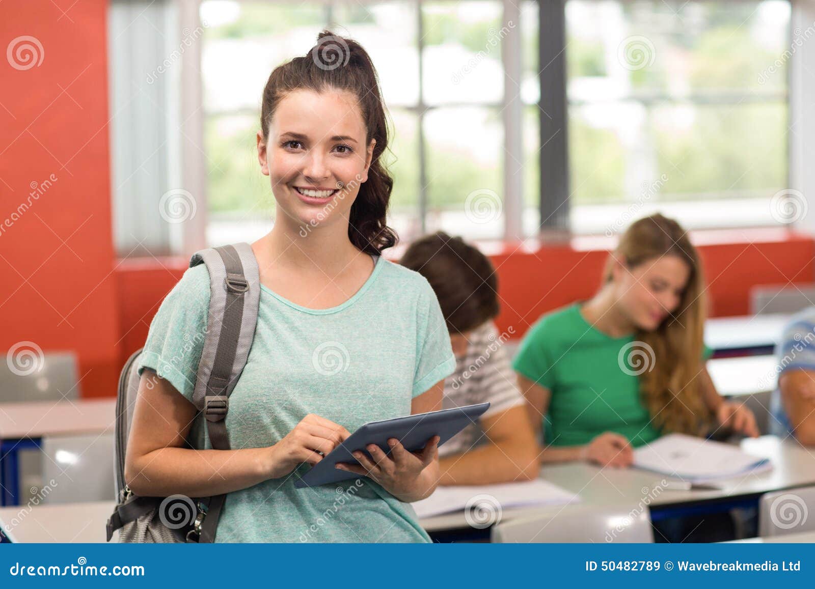 Female Student Using Digital Tablet in Classroom Stock Image - Image of ...