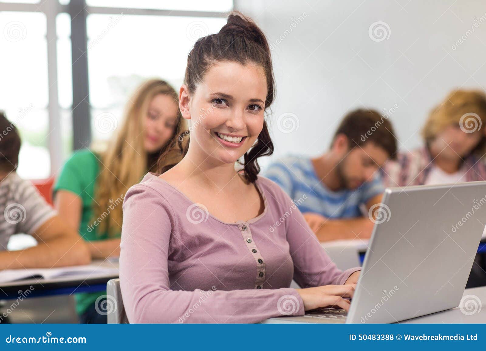 Female Student Using Laptop in Classroom Stock Photo - Image of college ...