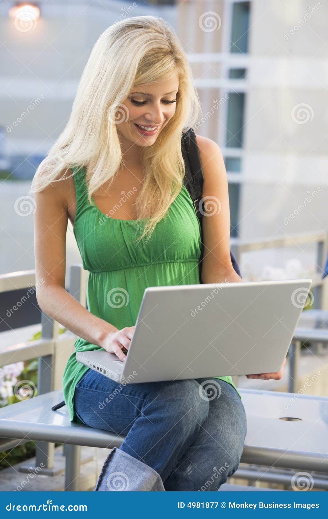 Female Student Using Laptop Outside Stock Image - Image of seated ...