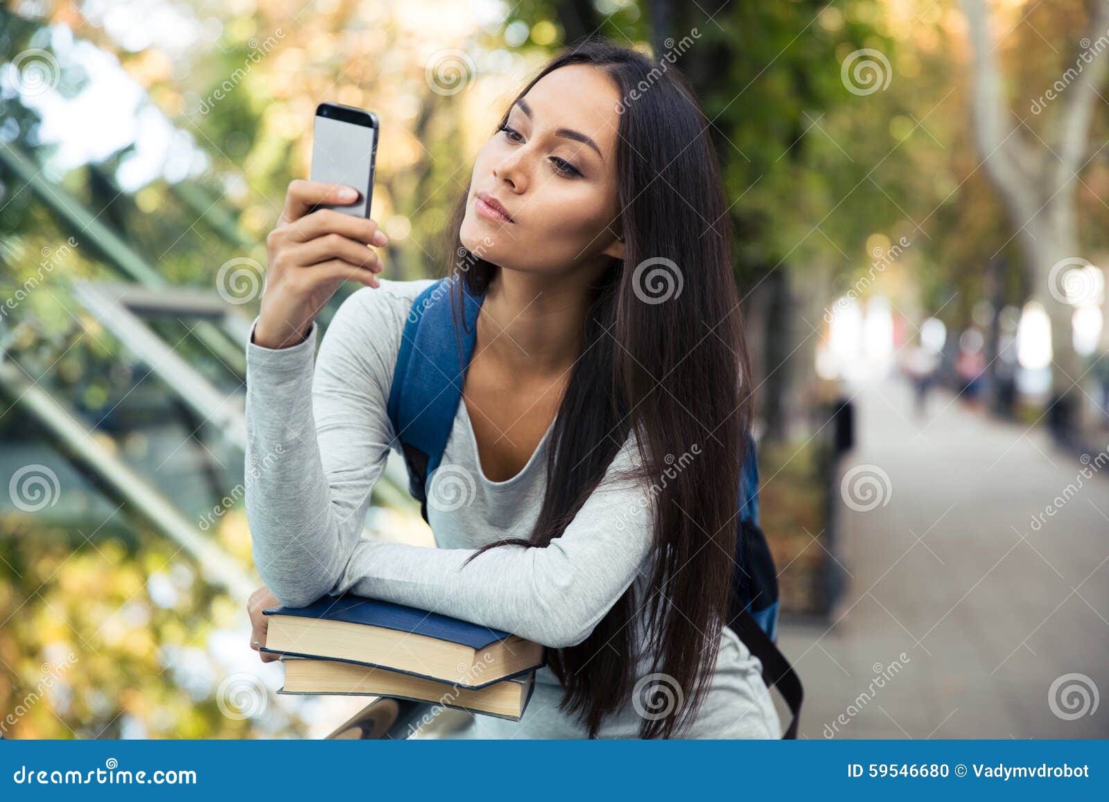 Female Student Using Smartphone Stock Photo - Image of outdoors ...
